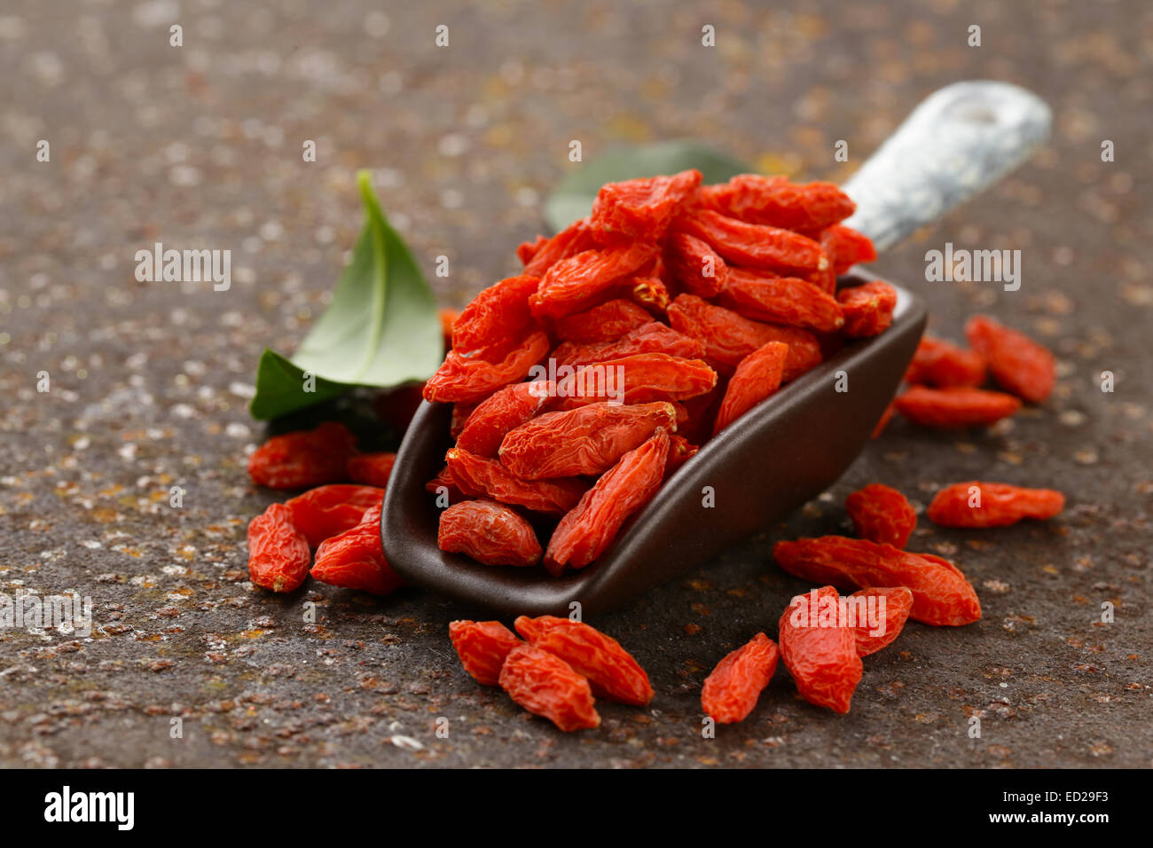 useful red goji berries on a old iron background Stock Photo - Alamy