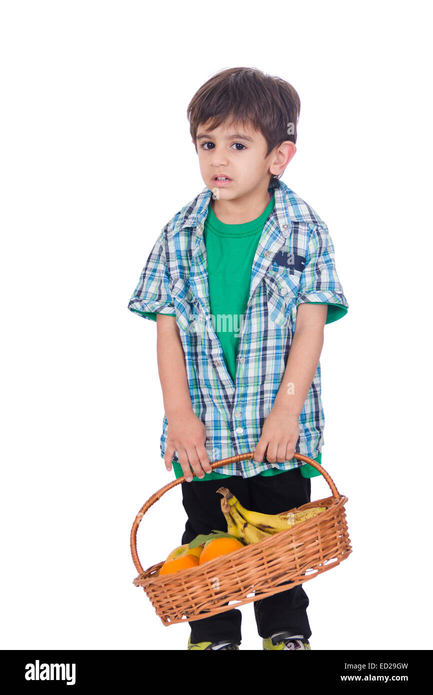 1 indian child boy eating Fruits Stock Photo - Alamy