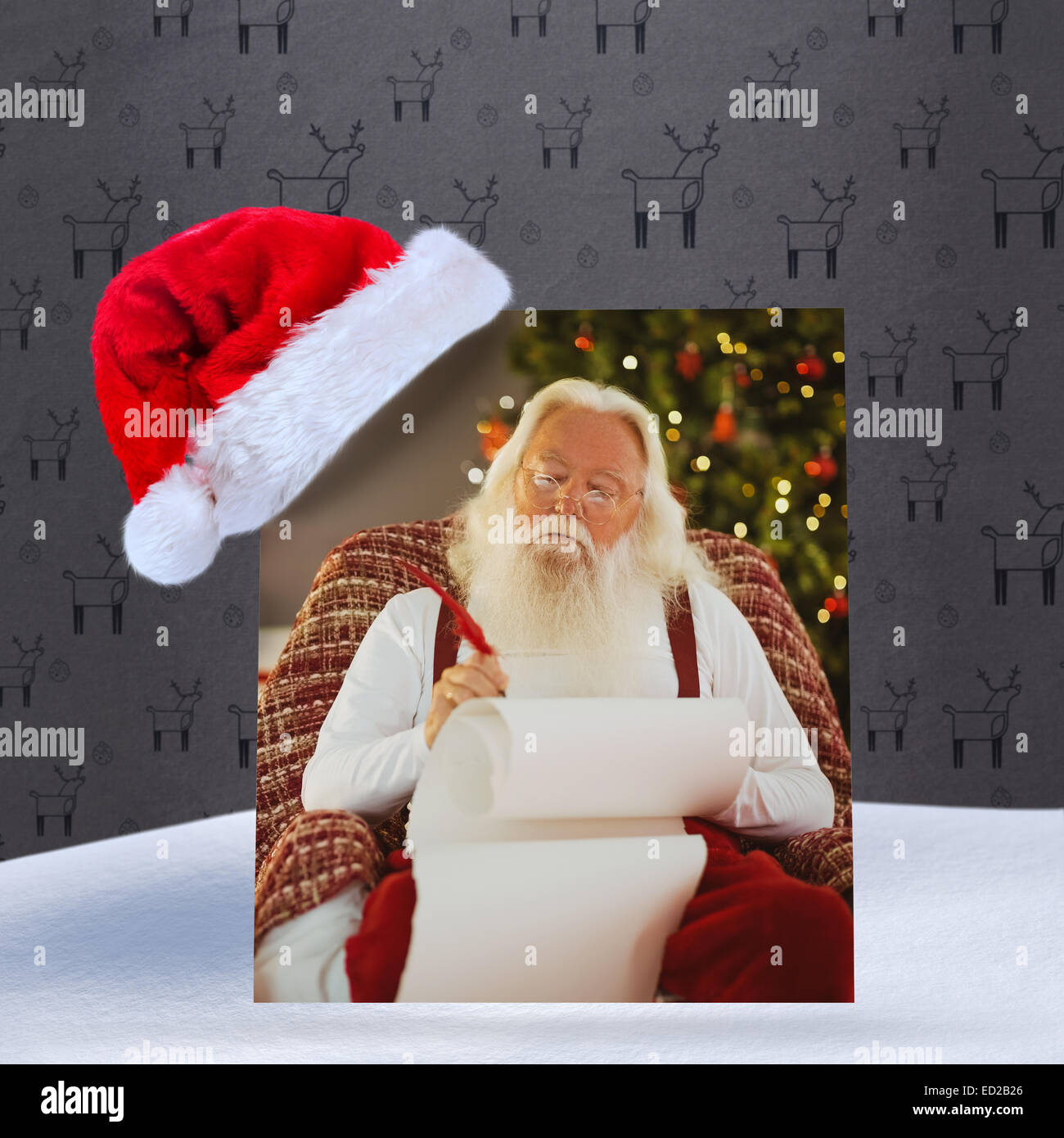Composite image of relaxed santa writing list with a quill Stock Photo ...