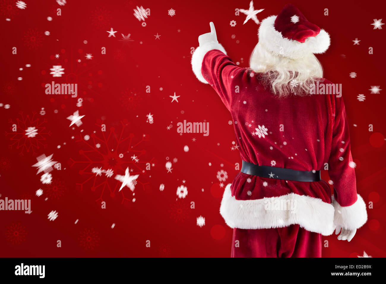 Composite image of santa claus points at something Stock Photo - Alamy