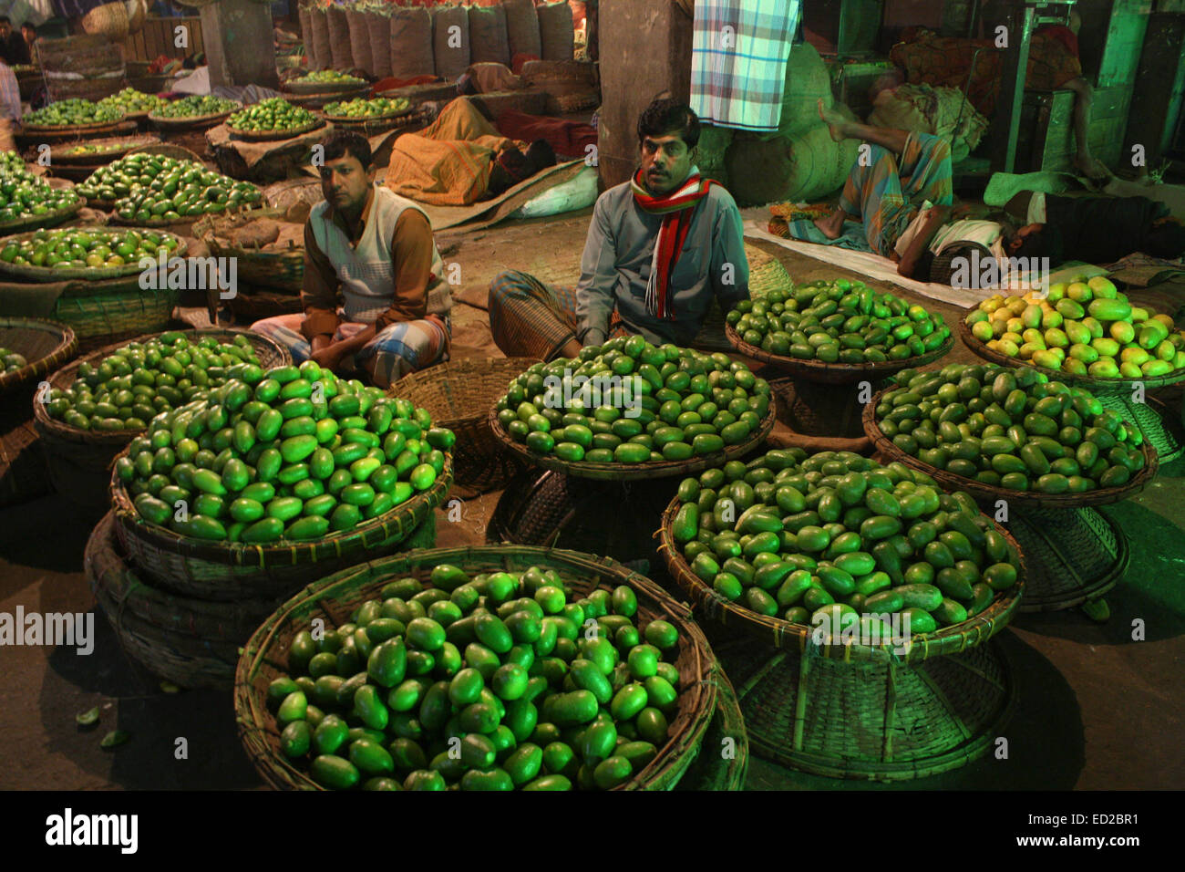 Bangladeshi lemon's vendor he waits for customers at a wholesale market ...