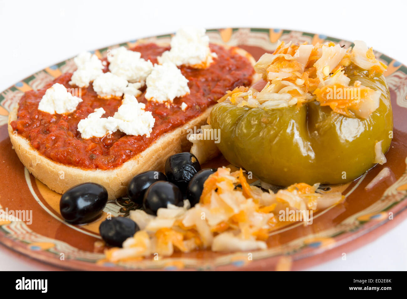 Slice of bread with chutney, sheese, pickle and olives in a painted ...