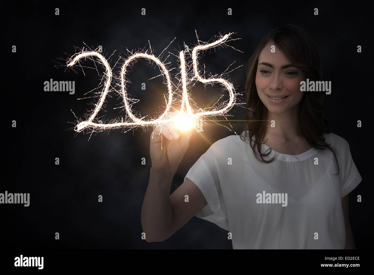 Composite image of businesswoman touching spark Stock Photo - Alamy
