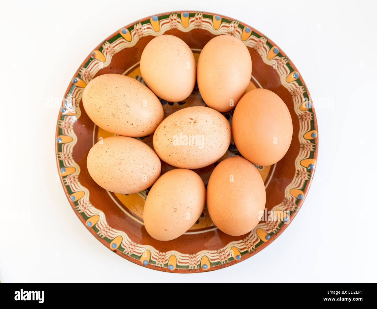 Eight eggs in painted ceramic plate isolated on white Stock Photo - Alamy
