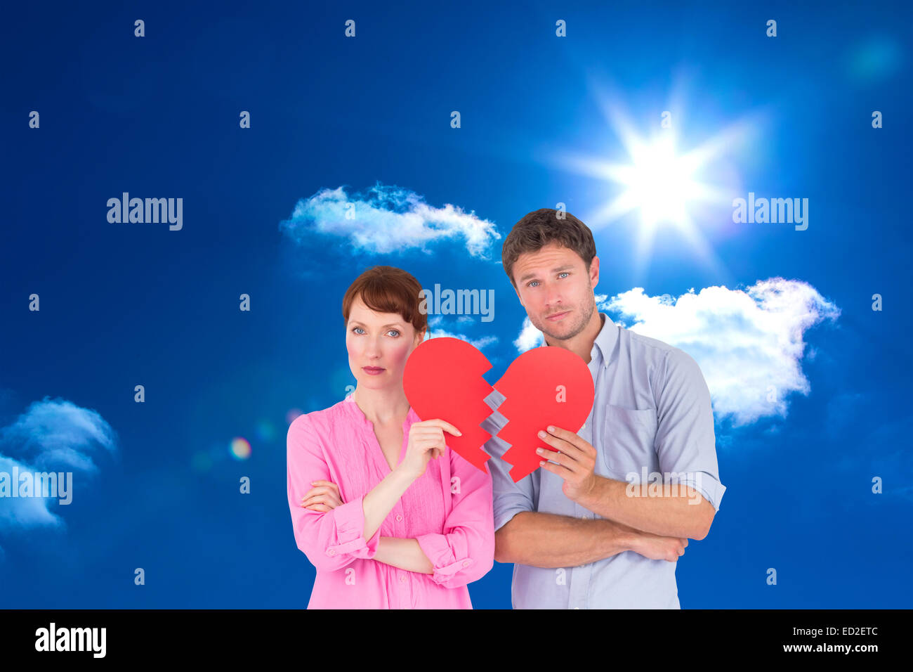 Composite image of couple holding a broken heart Stock Photo - Alamy