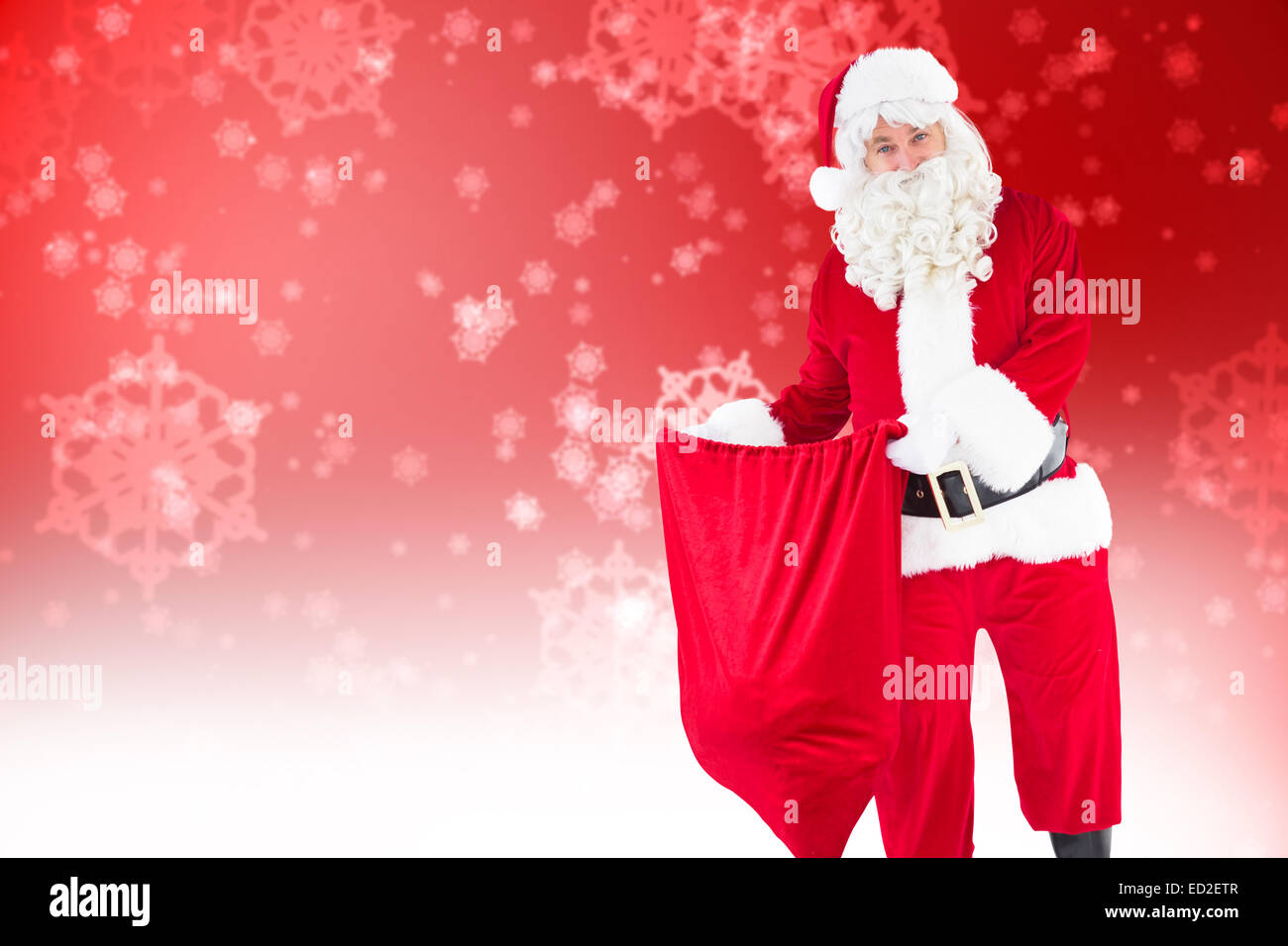 Composite image of smiling santa claus opening sack Stock Photo - Alamy