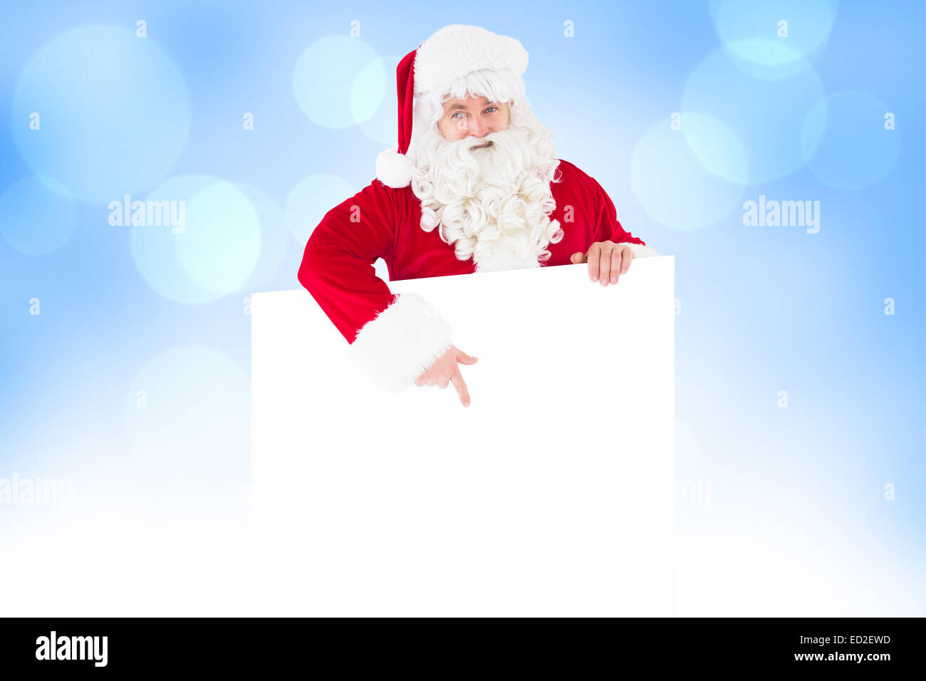 Composite image of happy santa claus presenting sign Stock Photo - Alamy