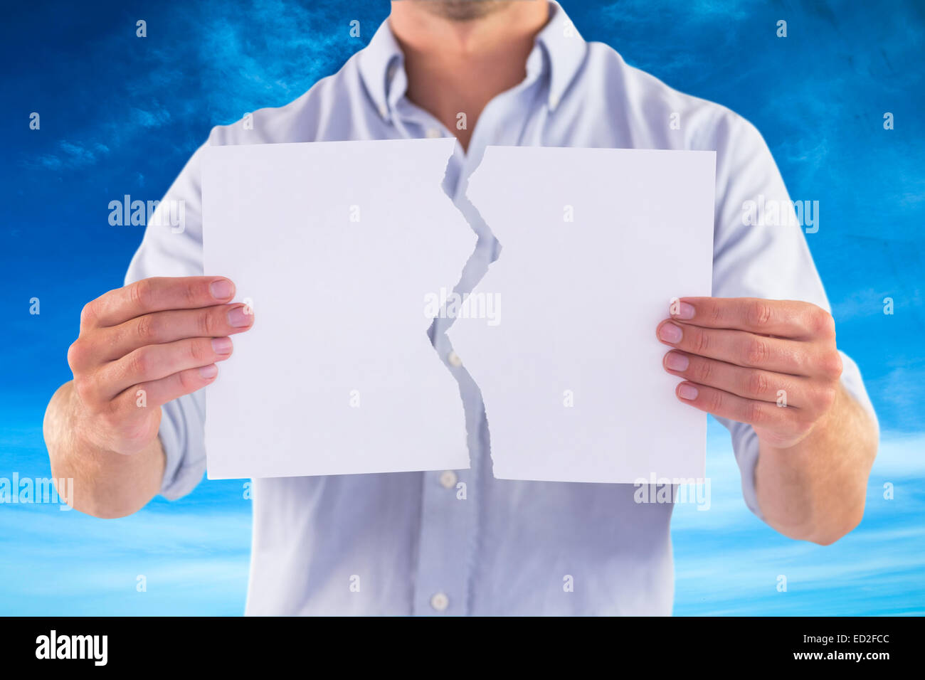 Composite image of man holding torn white paper Stock Photo - Alamy