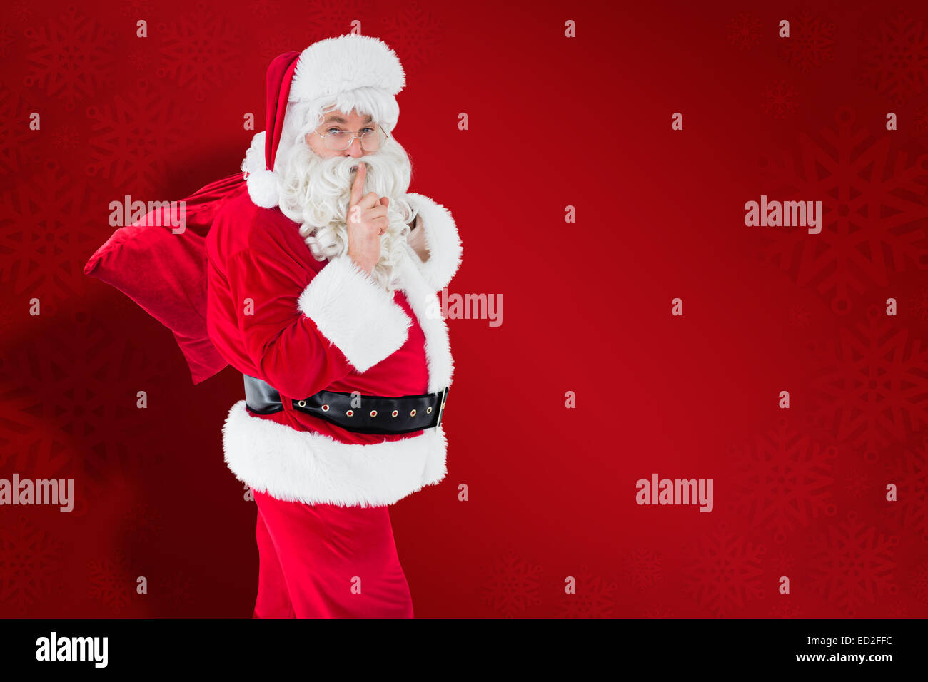 Composite image of santa keeping a secret and holding his sack Stock ...