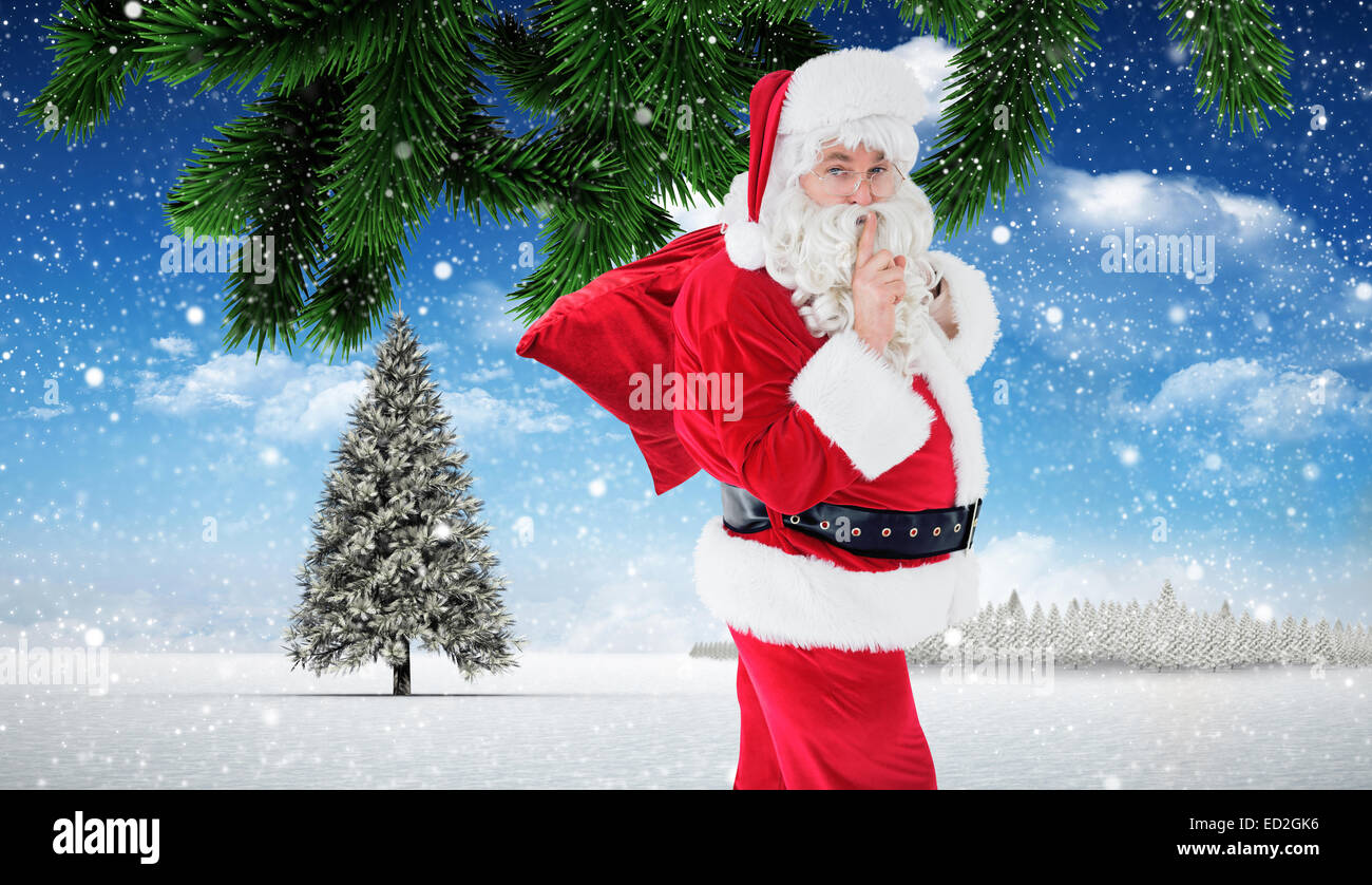 Composite image of santa keeping a secret and holding his sack Stock ...