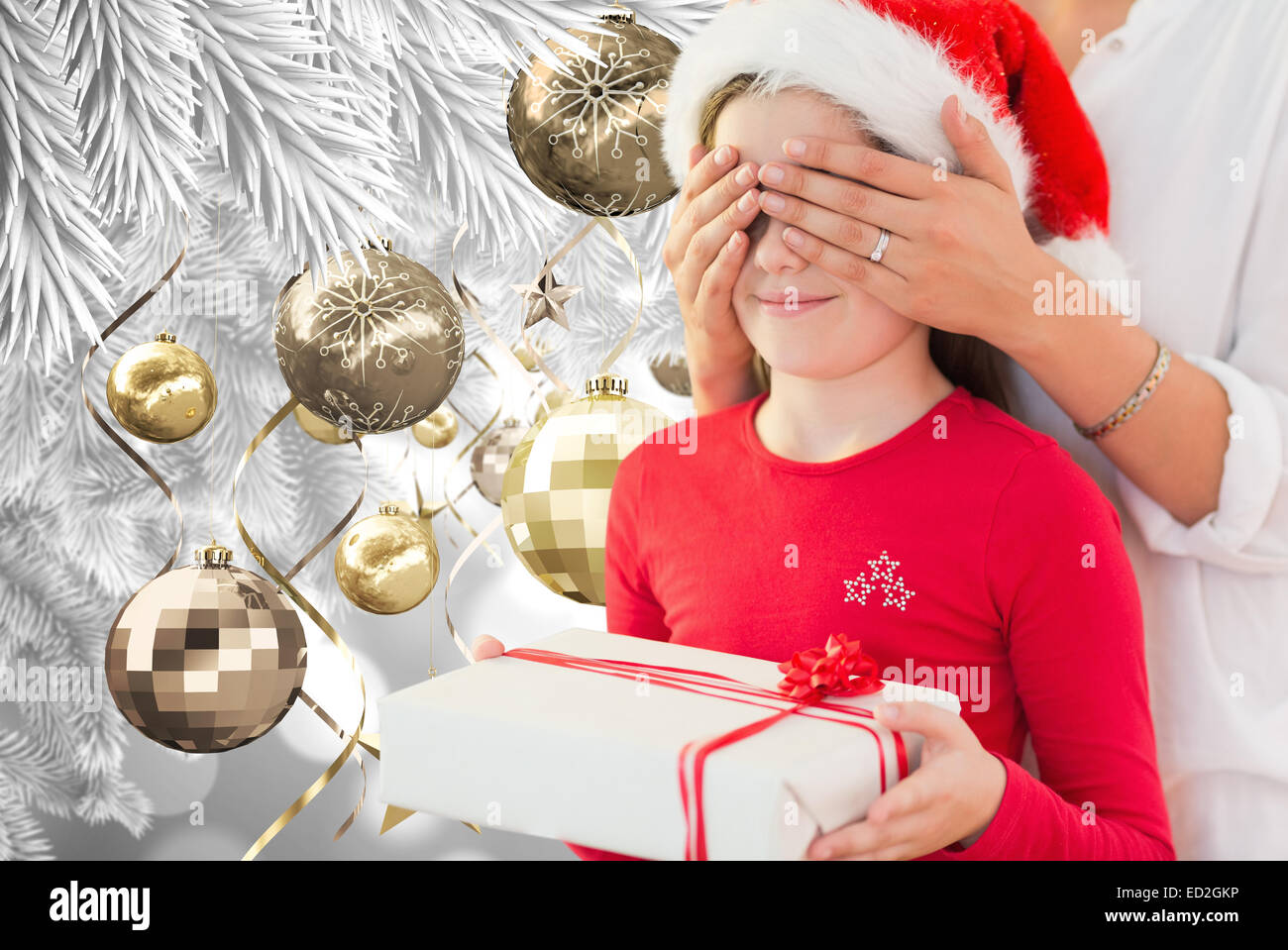 Composite image of little girl getting gift Stock Photo - Alamy