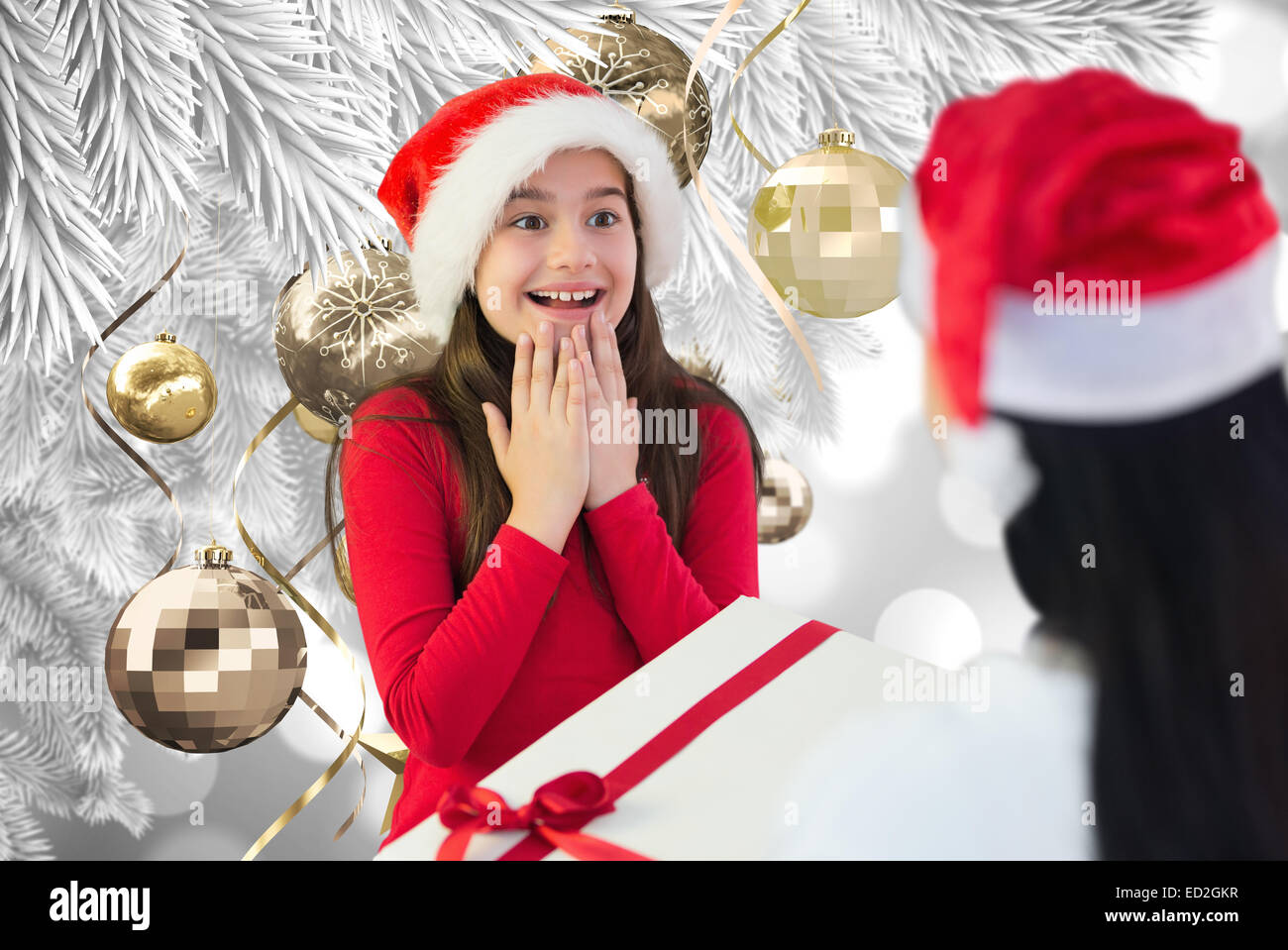Composite image of little girl getting gift Stock Photo - Alamy