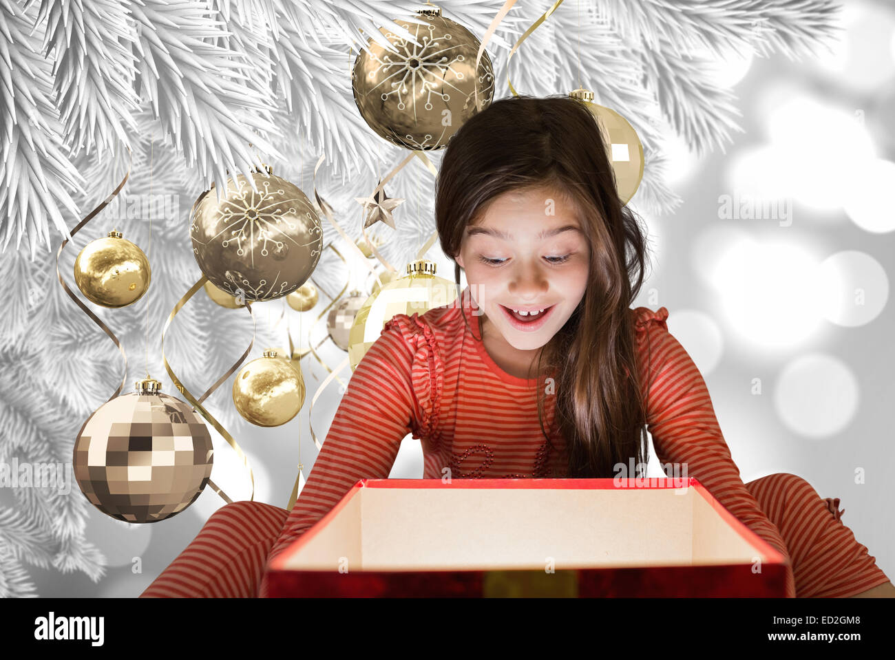 Composite image of little girl getting gift Stock Photo - Alamy