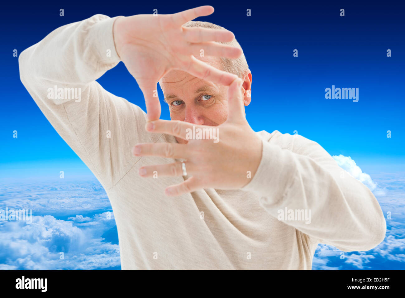 Composite image of happy mature man framing with hands Stock Photo - Alamy