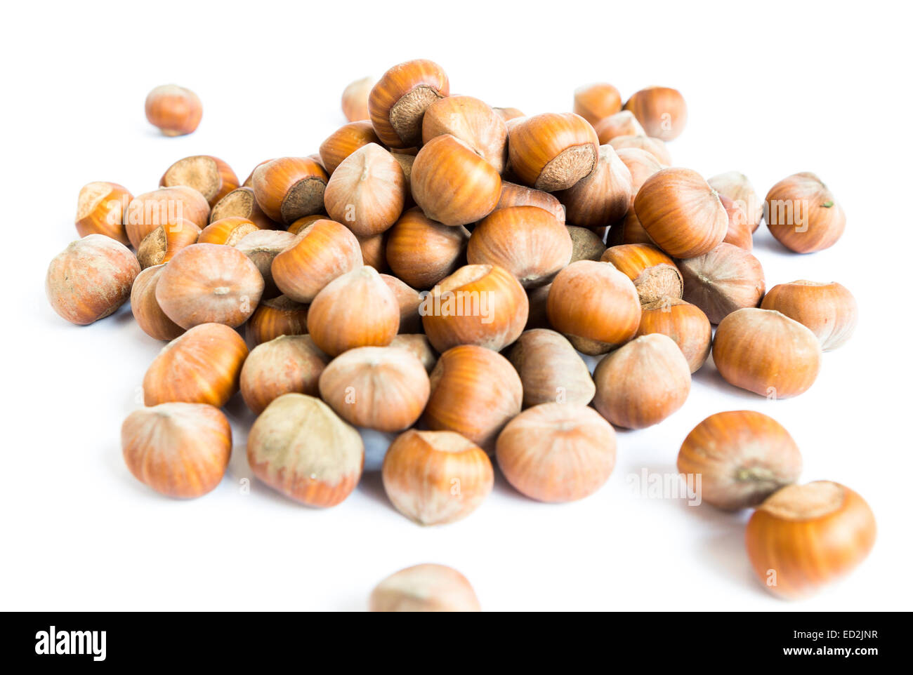 Unpeeled hazelnuts on white. Healthy organic eating Stock Photo - Alamy