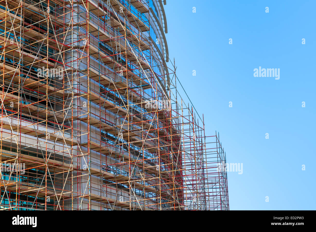 Modern building is under construction, metal scaffolding and sky Stock ...