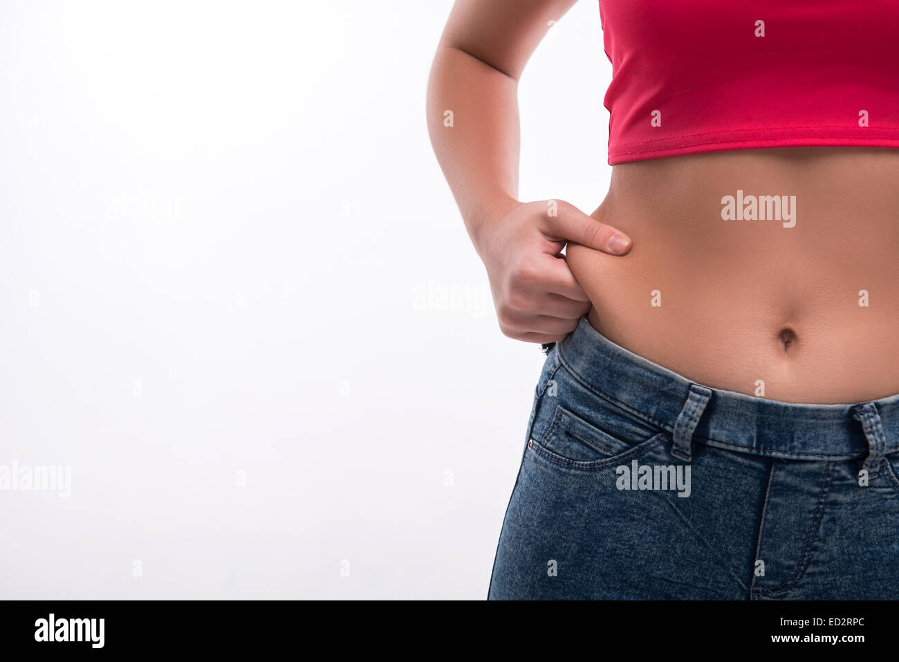 Young woman pinching waist hi-res stock photography and images - Alamy