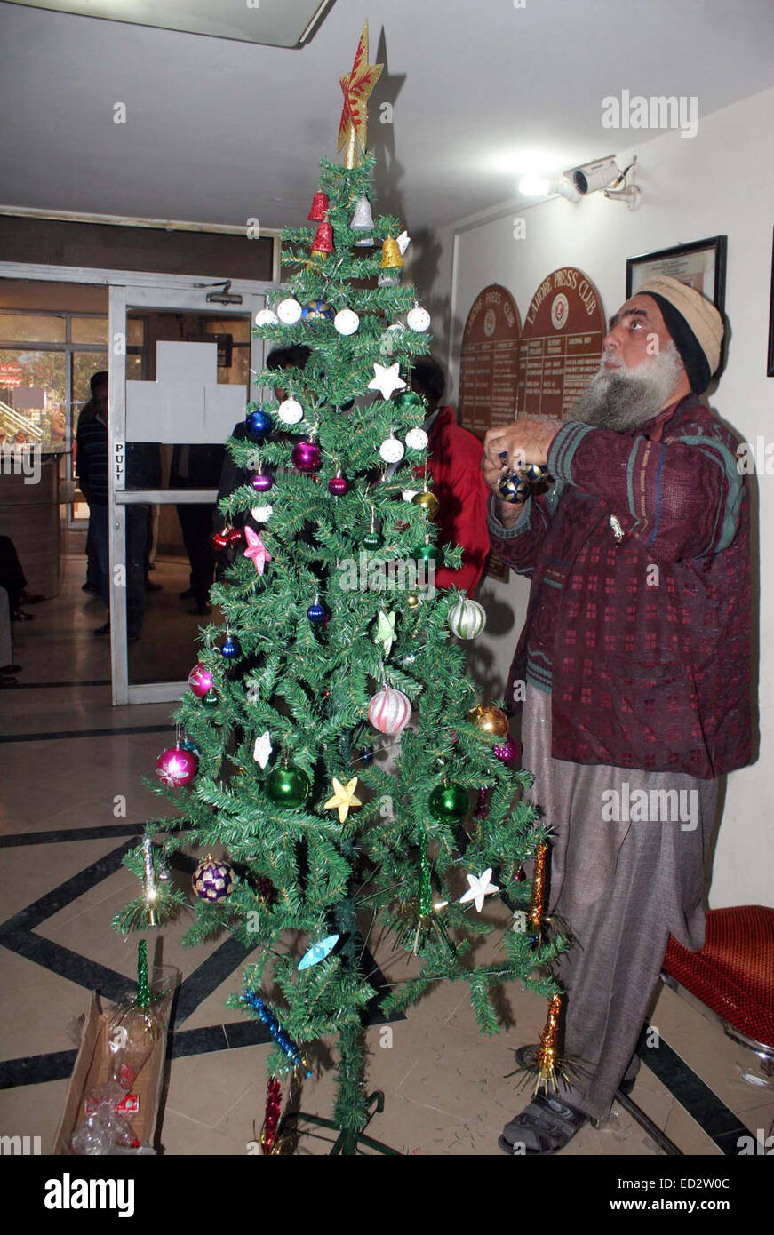 Employee busies in decorating Christmas tree in connection of ...