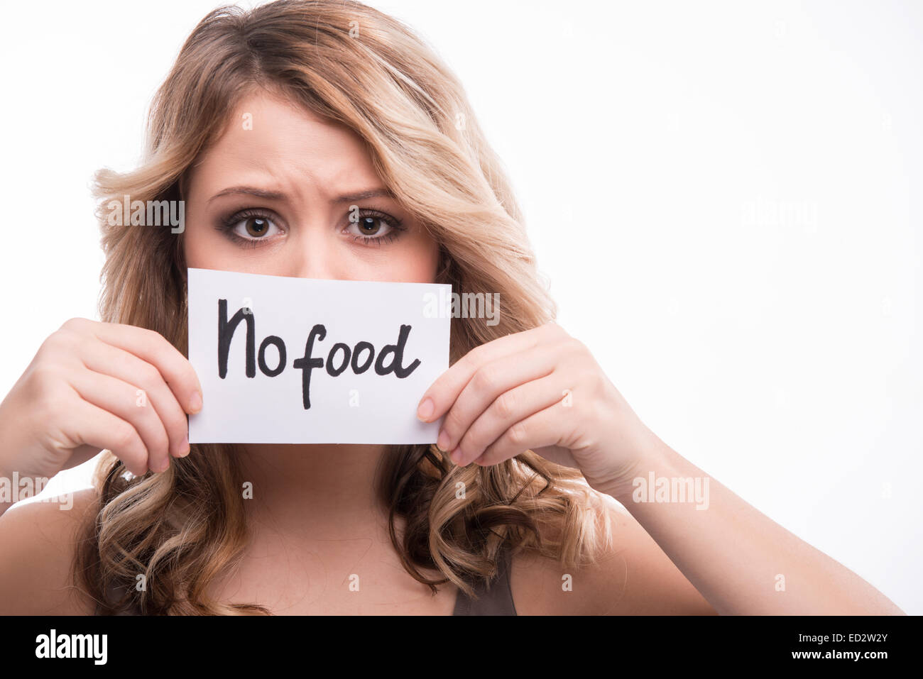 Portrait of young attractive woman holding warning notice card i Stock ...