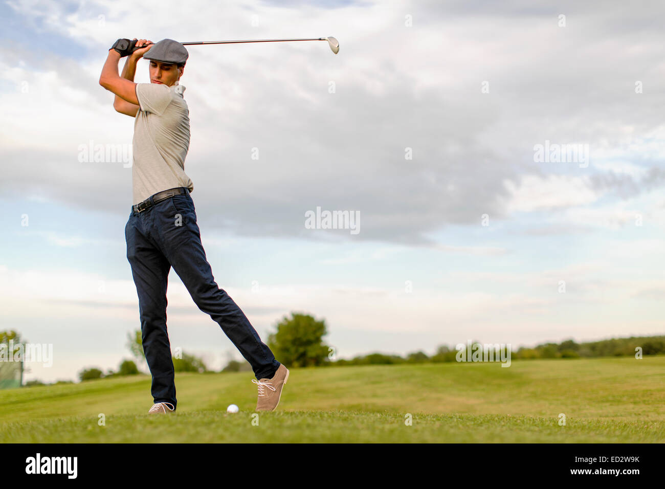 Young man playing golf Stock Photo - Alamy