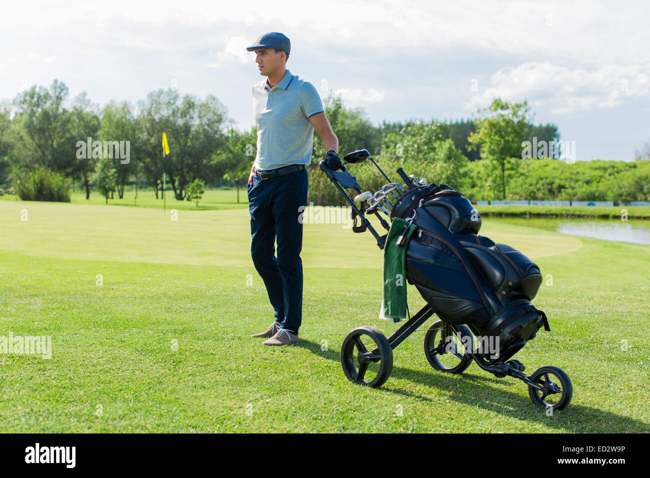 Young man playing golf Stock Photo - Alamy