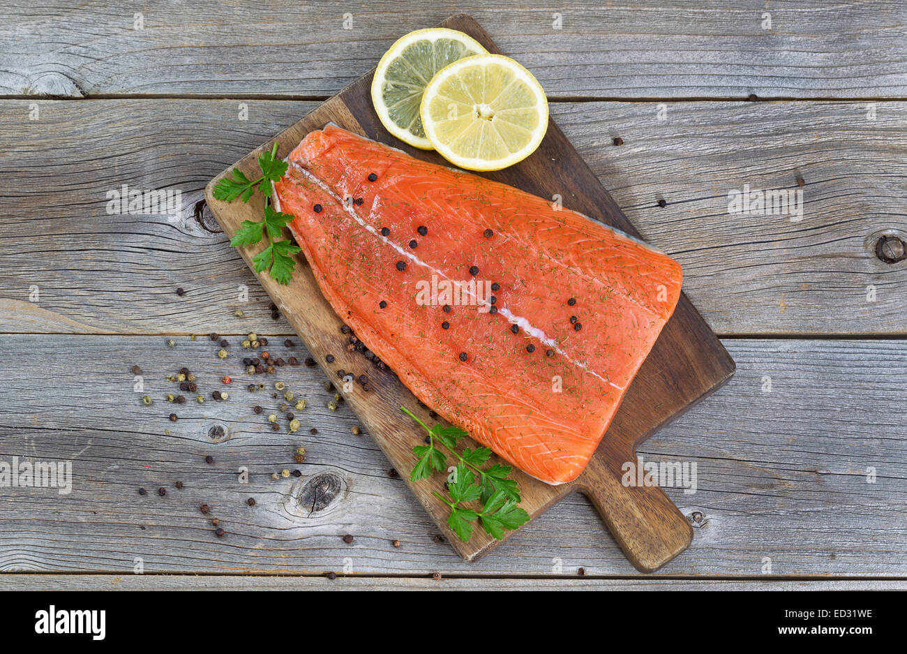 Top view image of a fresh salmon fillet with herbs, spices and lemon ...
