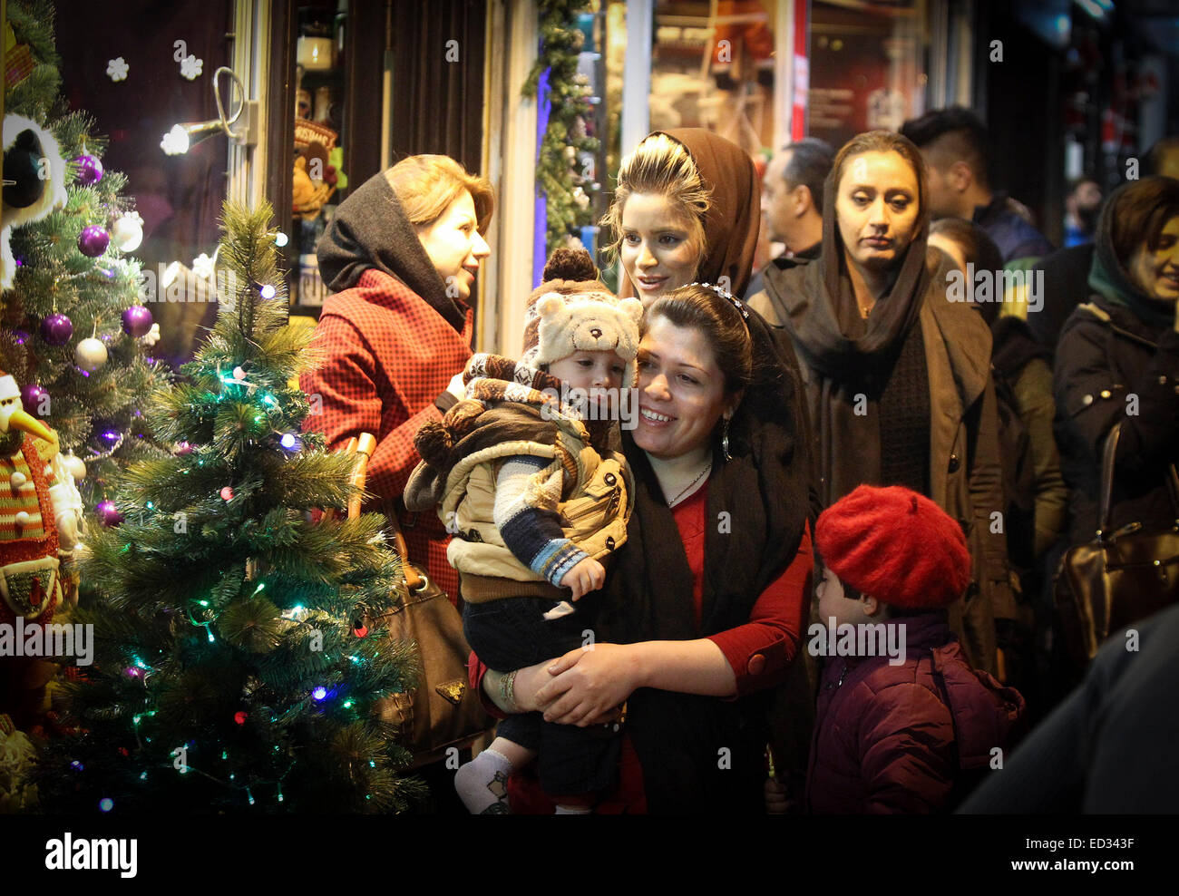 Tehran, Iran. 24th Dec, 2014. People are seen around Christmas ...
