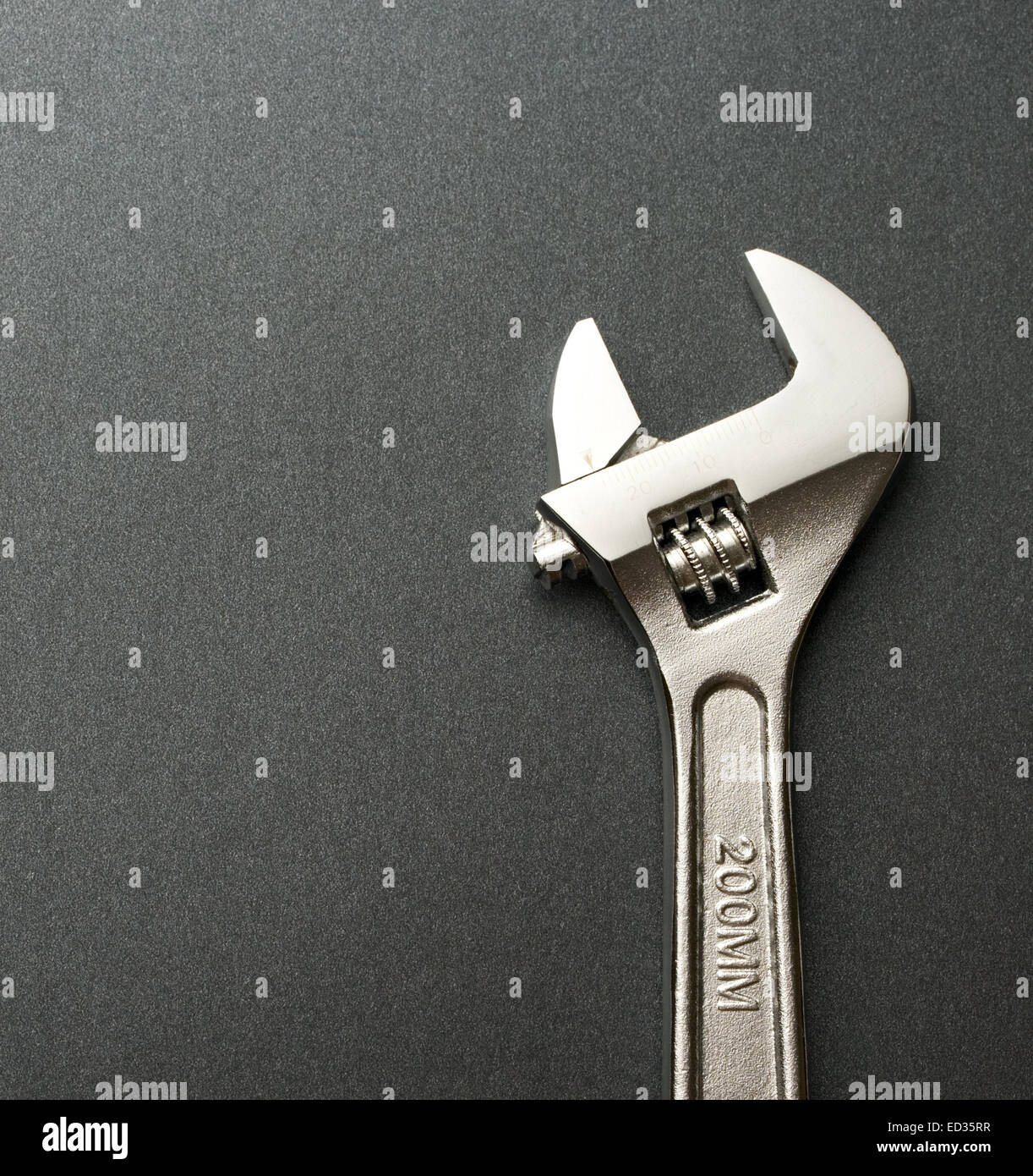 Spanner on a grey background Stock Photo - Alamy