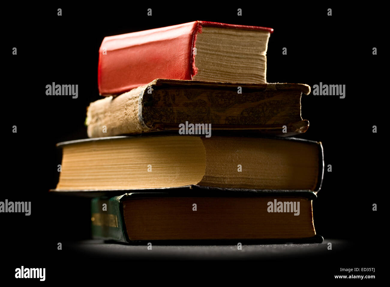 A pile of old books on black Stock Photo - Alamy