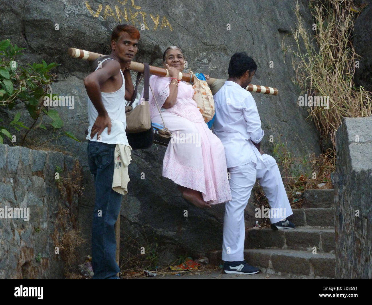 men carry pilgrim to the jain temple in junagadh india Stock Photo - Alamy