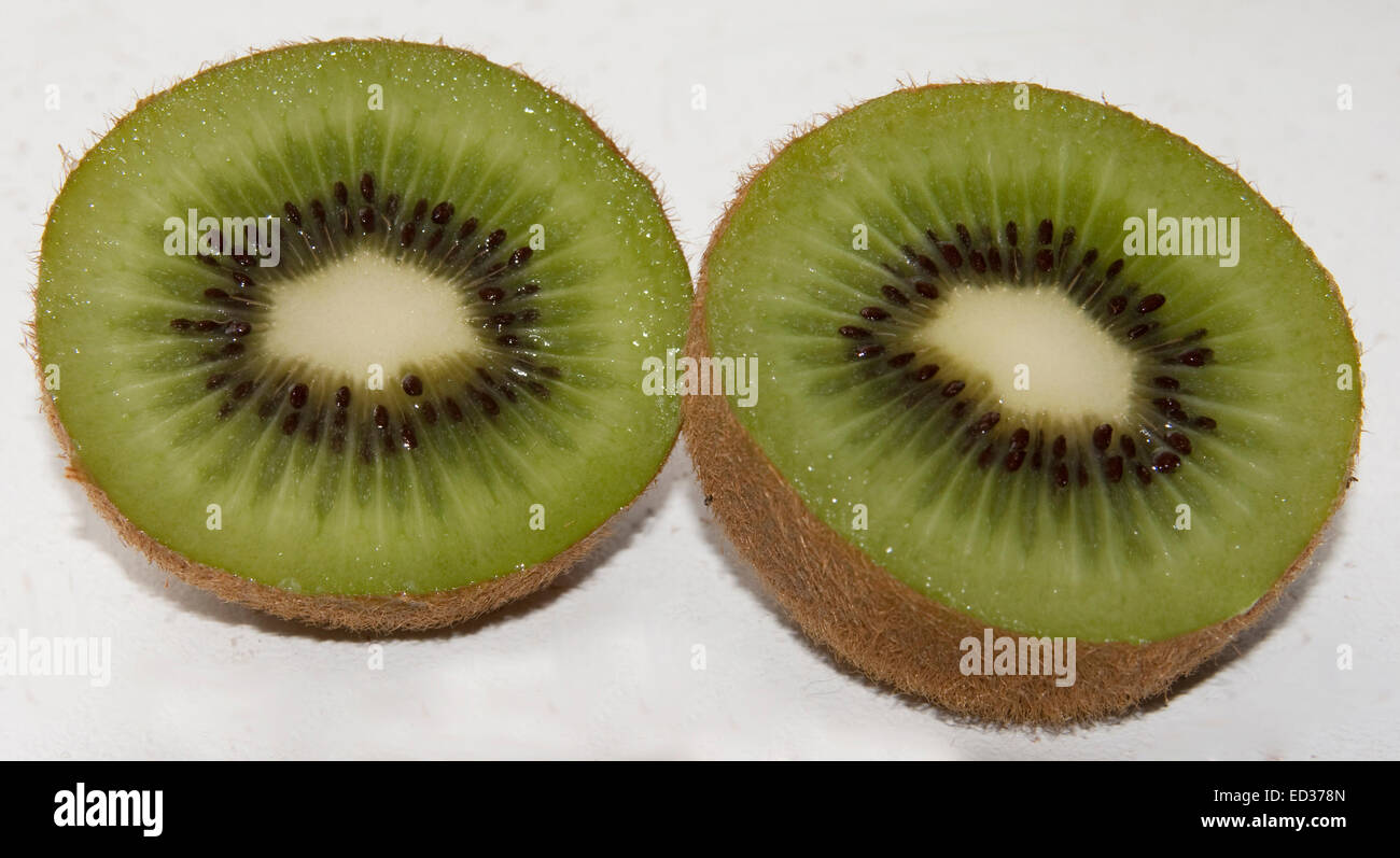Two halves of fresh kiwi fruit / Chinese gooseberry, cut open and ...