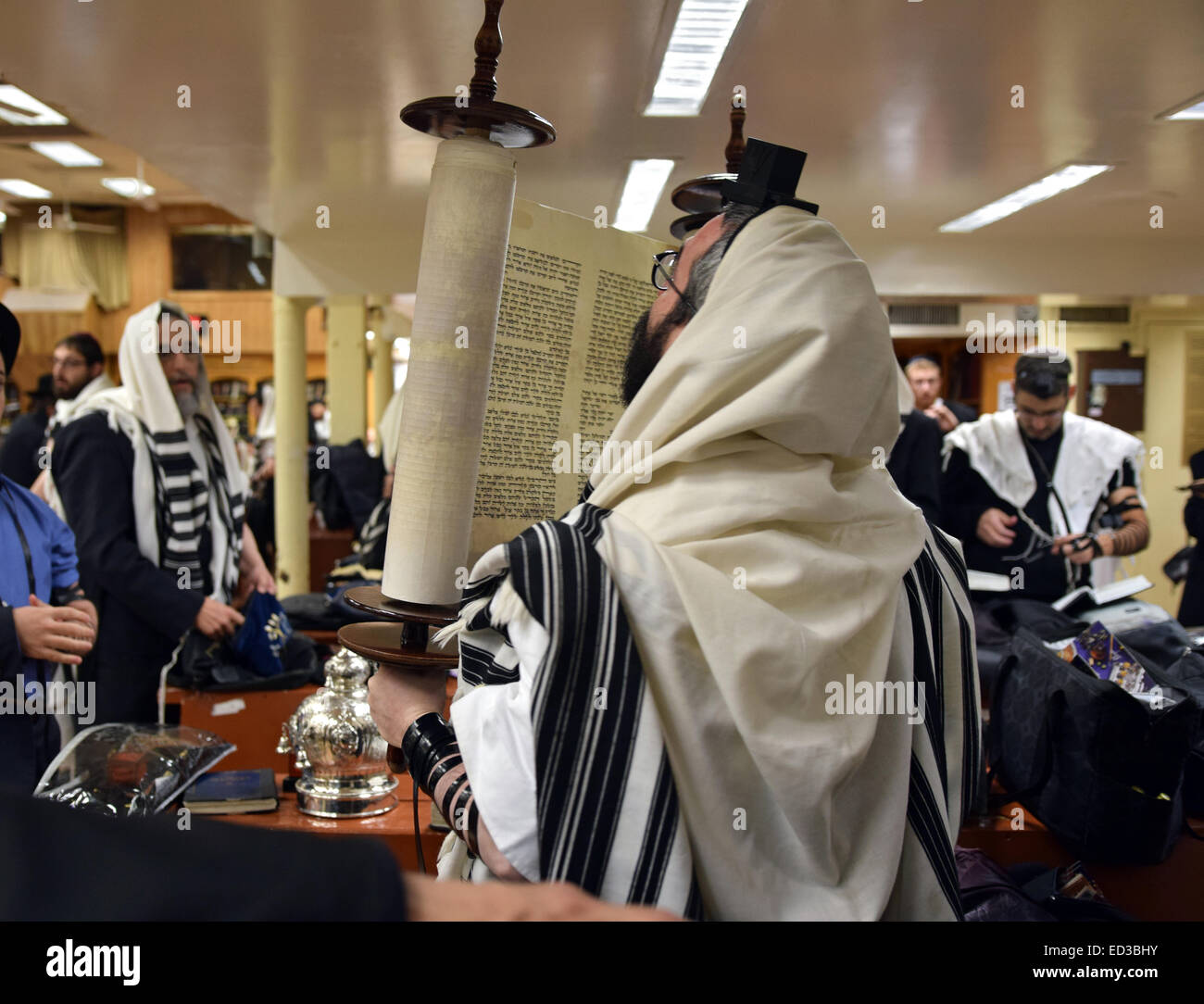 Torah scroll raised after a reading at morning services at a synagogue ...