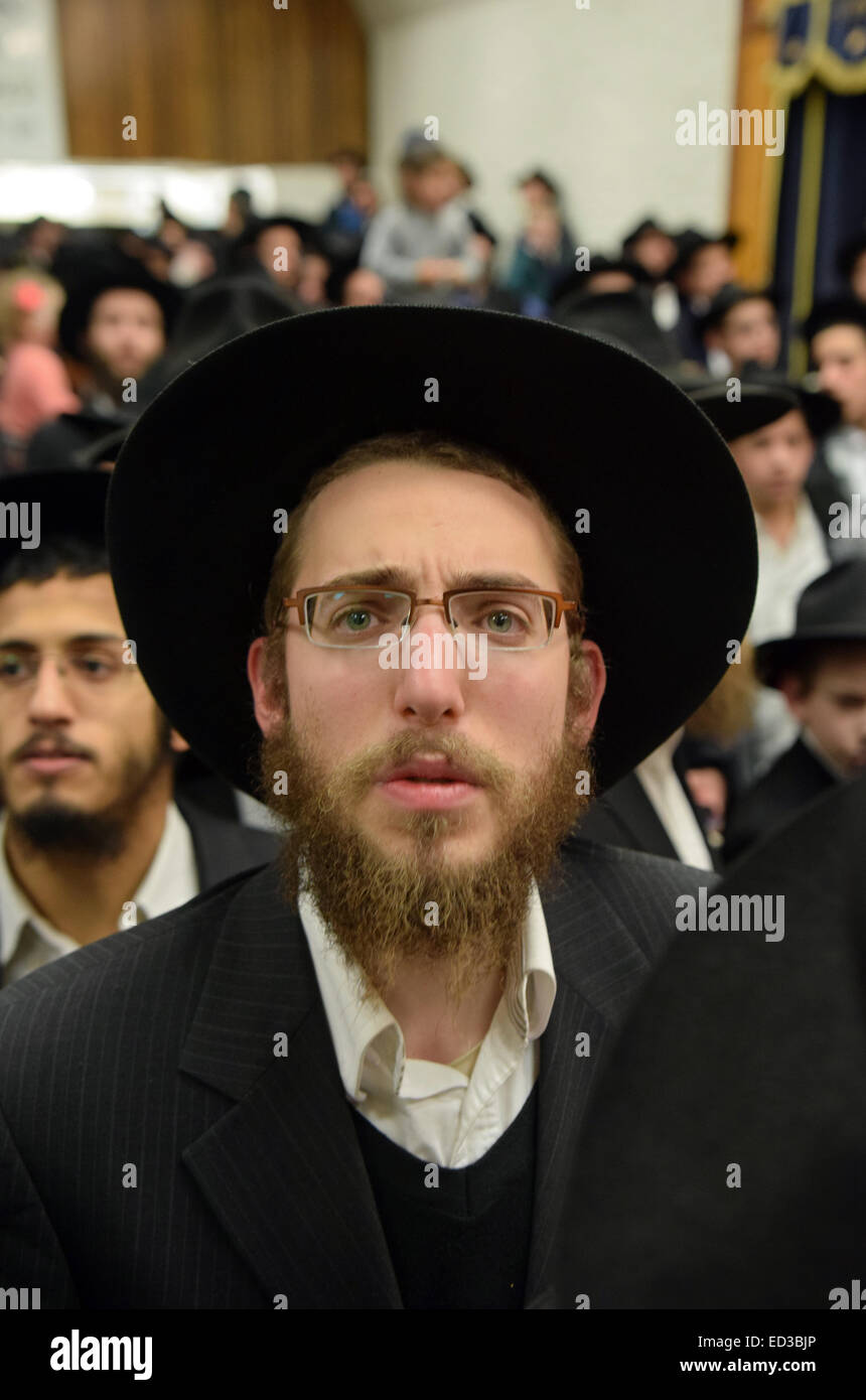 A serious looking religious Jewish man at afternoon services in a ...