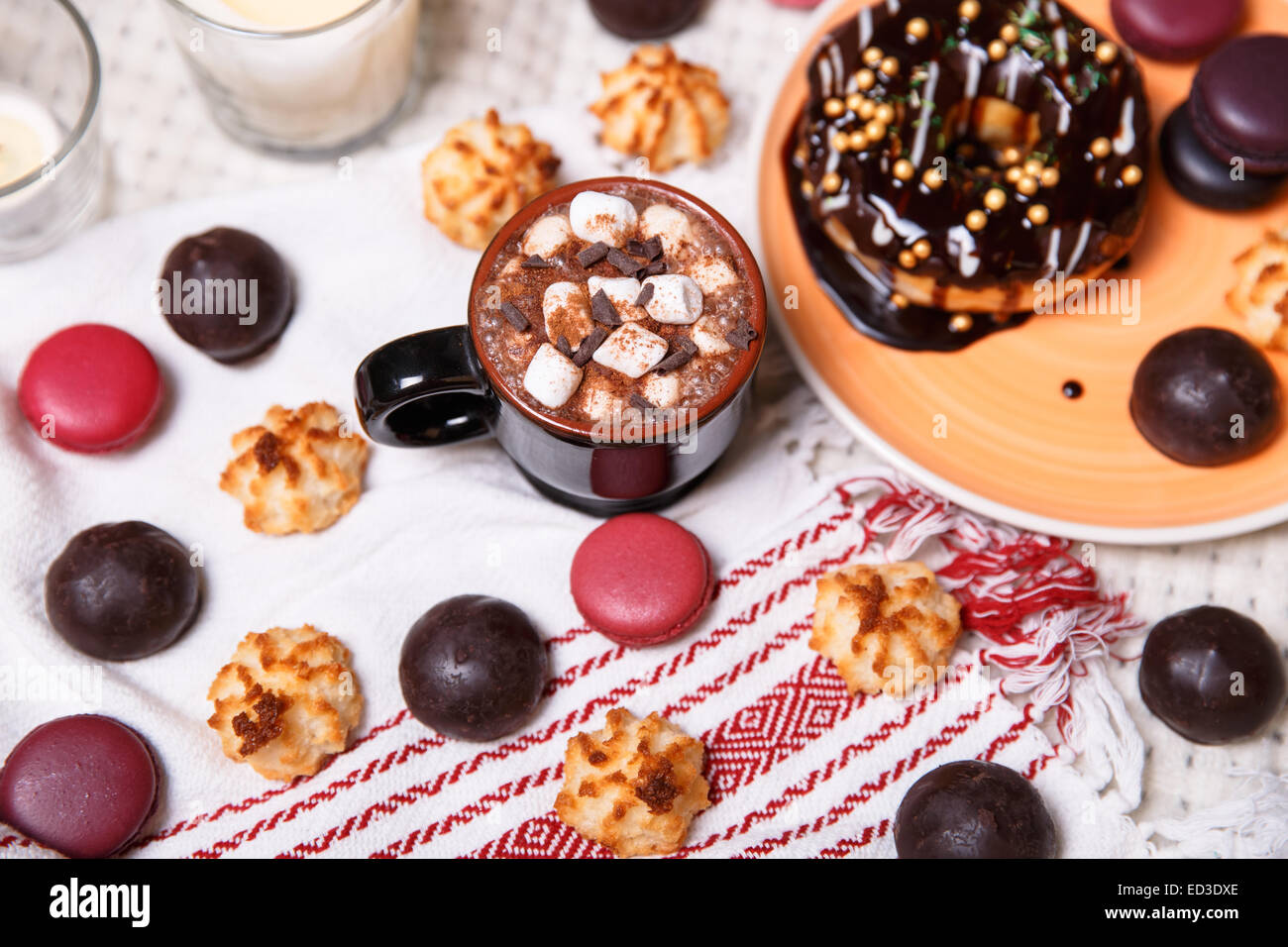 colorful Christmas sweets and hot drinks on the holiday table near the ...