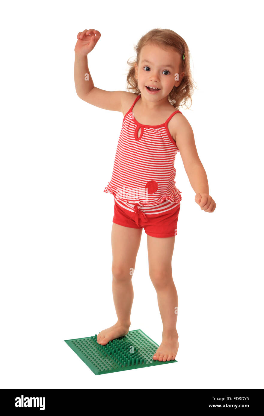 Girl with a massage carpet Stock Photo - Alamy