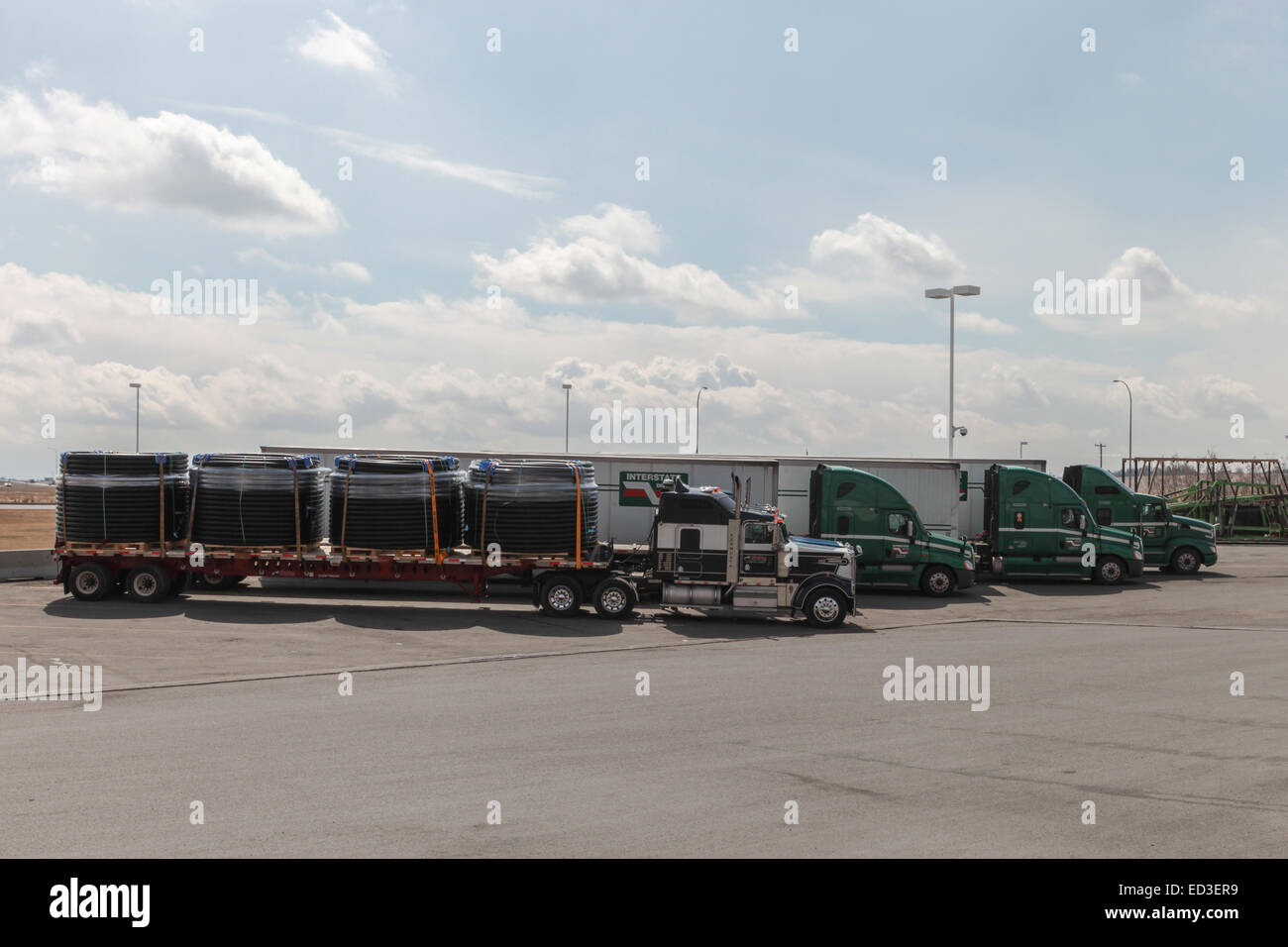 Reels of plastic underground pipe on flatdeck trailer heading for the ...