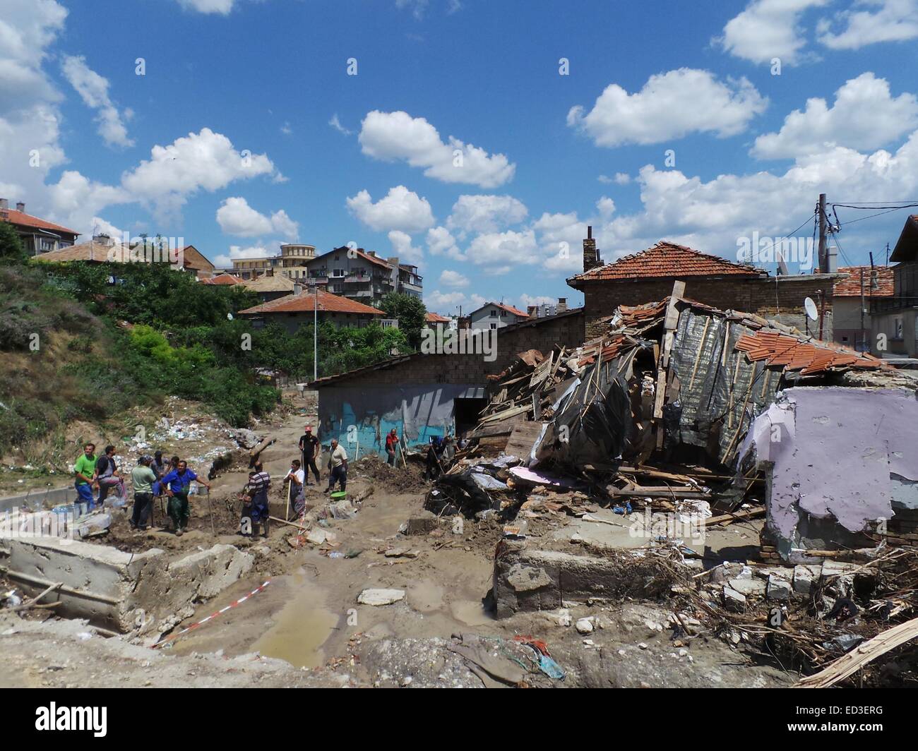 People and rescue workers search for survivers and try to clean homes ...