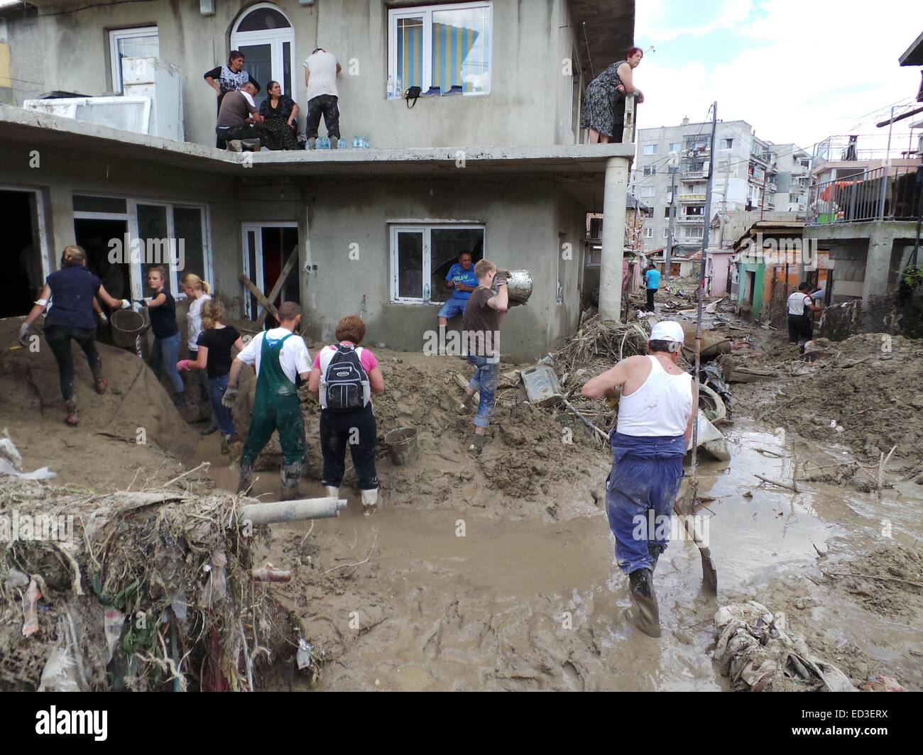 People and rescue workers search for survivers and try to clean homes ...