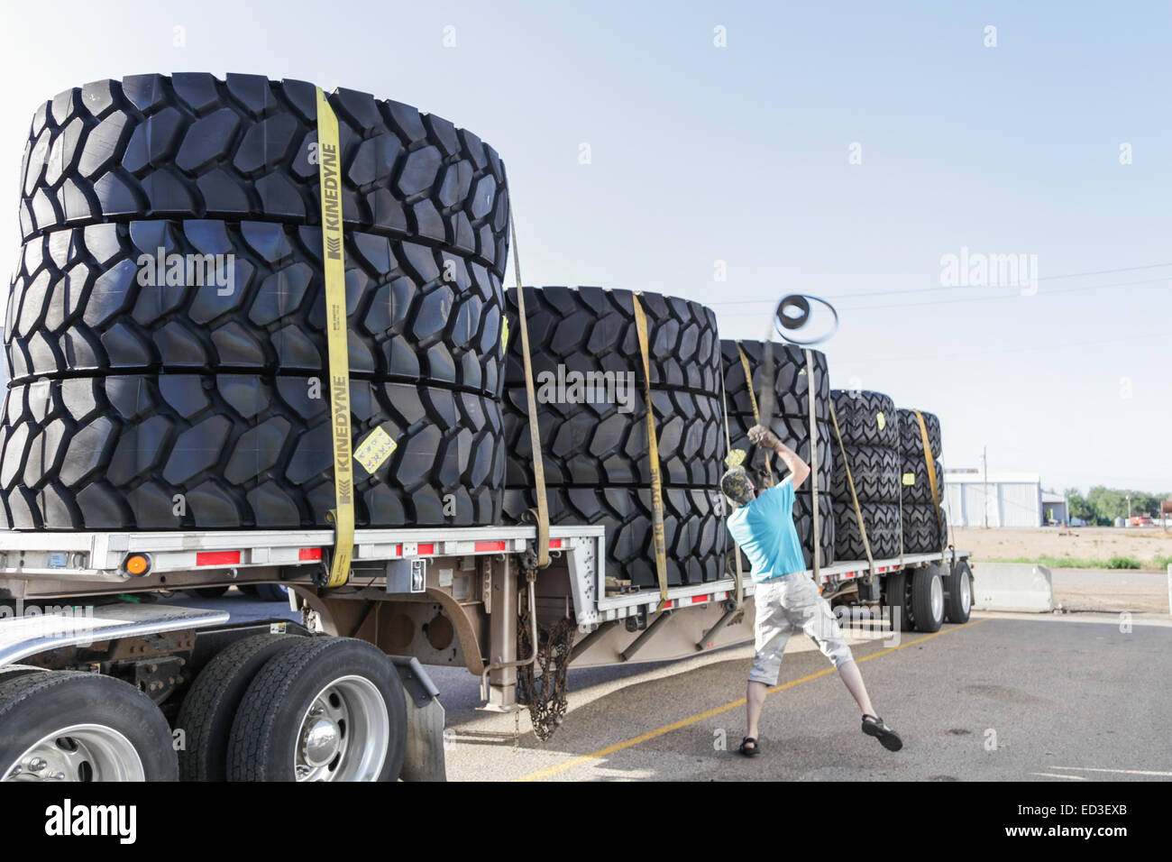 Peterbilt truck with load of large mining tyres on flatdeck trailer and ...