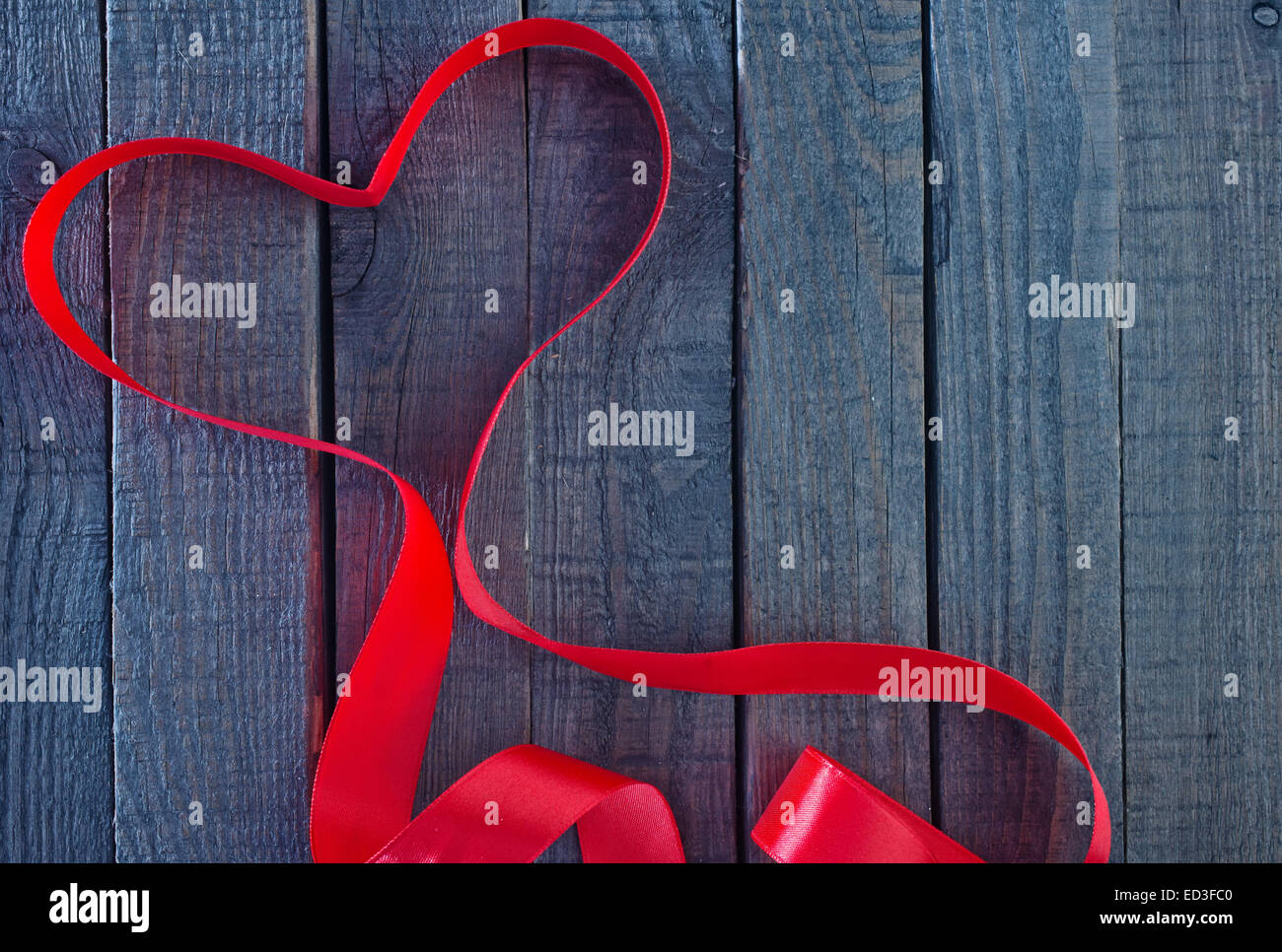 red heart ribbon on the wooden background Stock Photo - Alamy