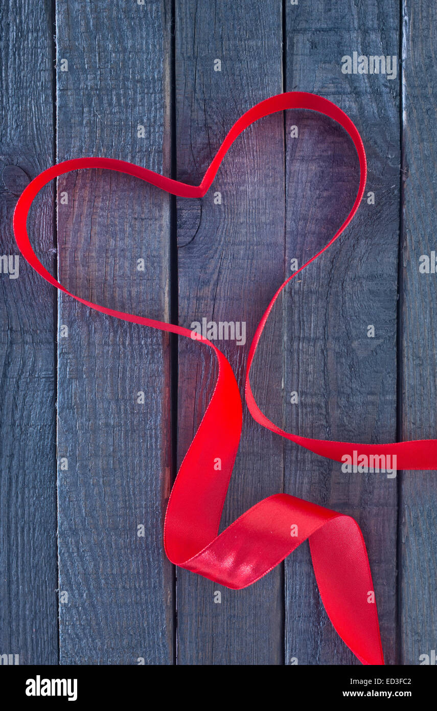 red heart ribbon on the wooden background Stock Photo - Alamy