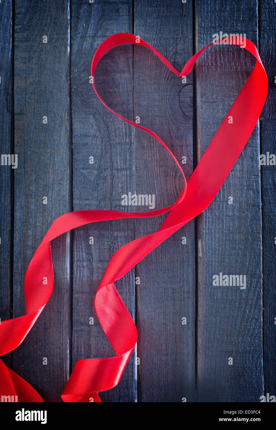 red heart ribbon on the wooden background Stock Photo - Alamy