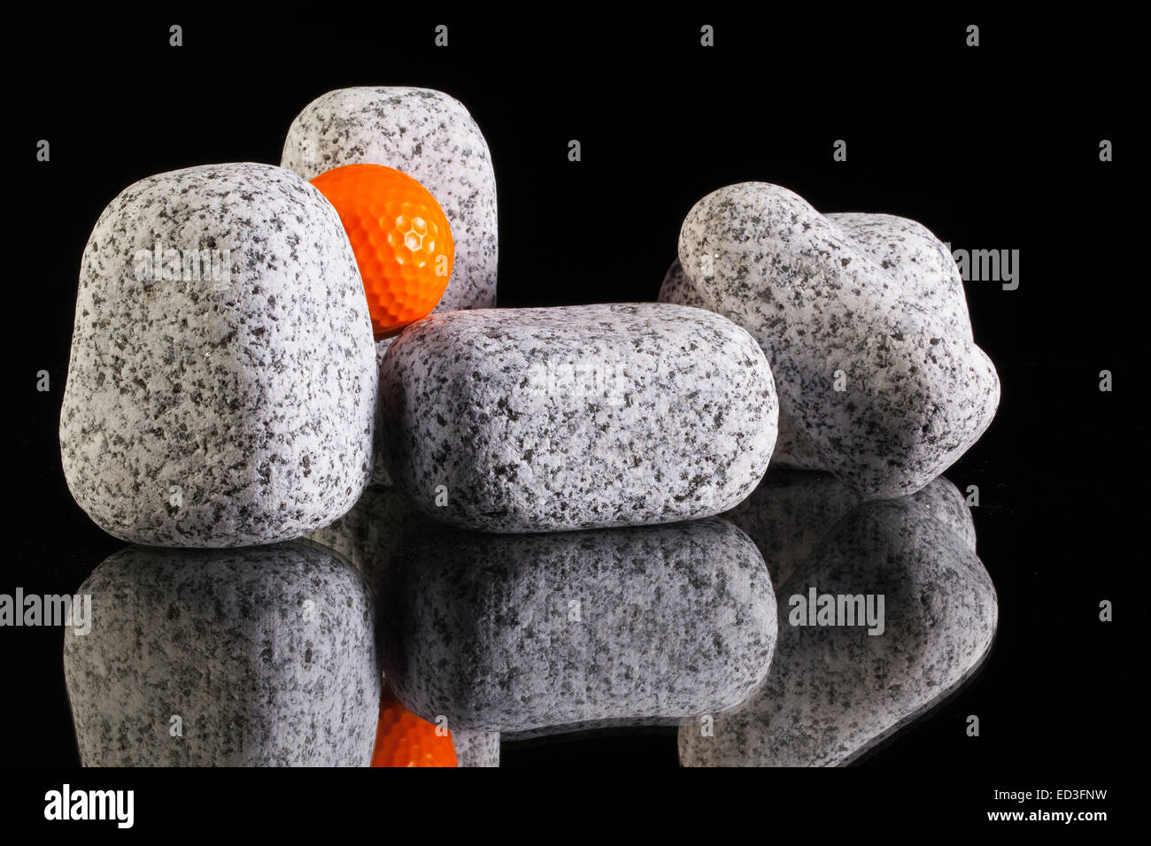 Different granite stones and golf ball on a glass Stock Photo - Alamy