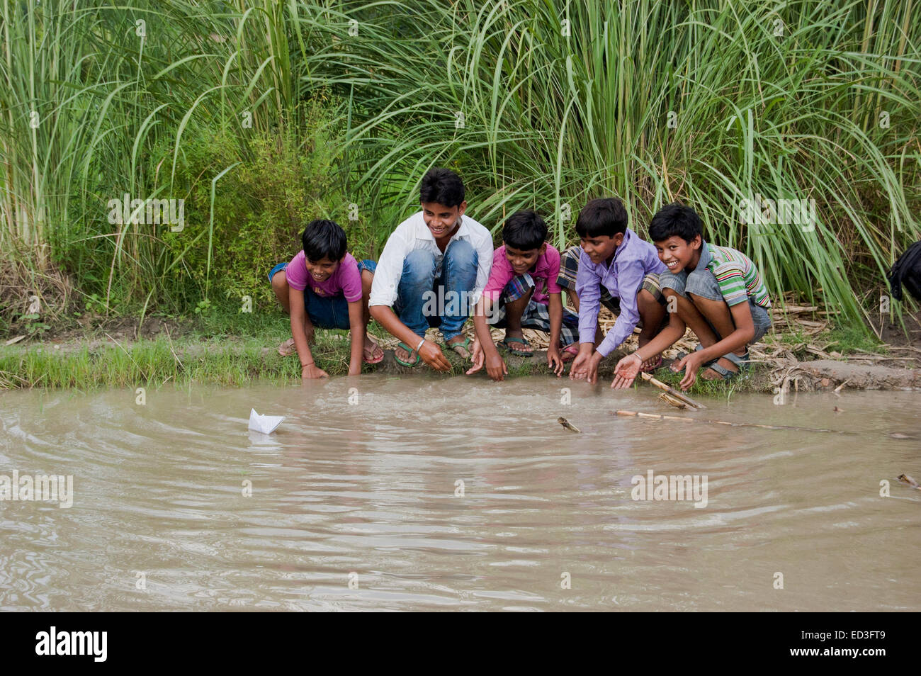 indian rural children boys Pond Playing Paper Boat Stock Photo - Alamy