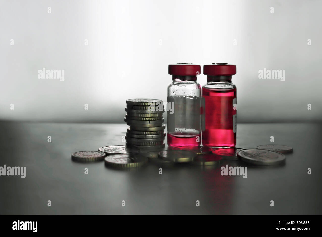 Vials and Coins Stock Photo - Alamy