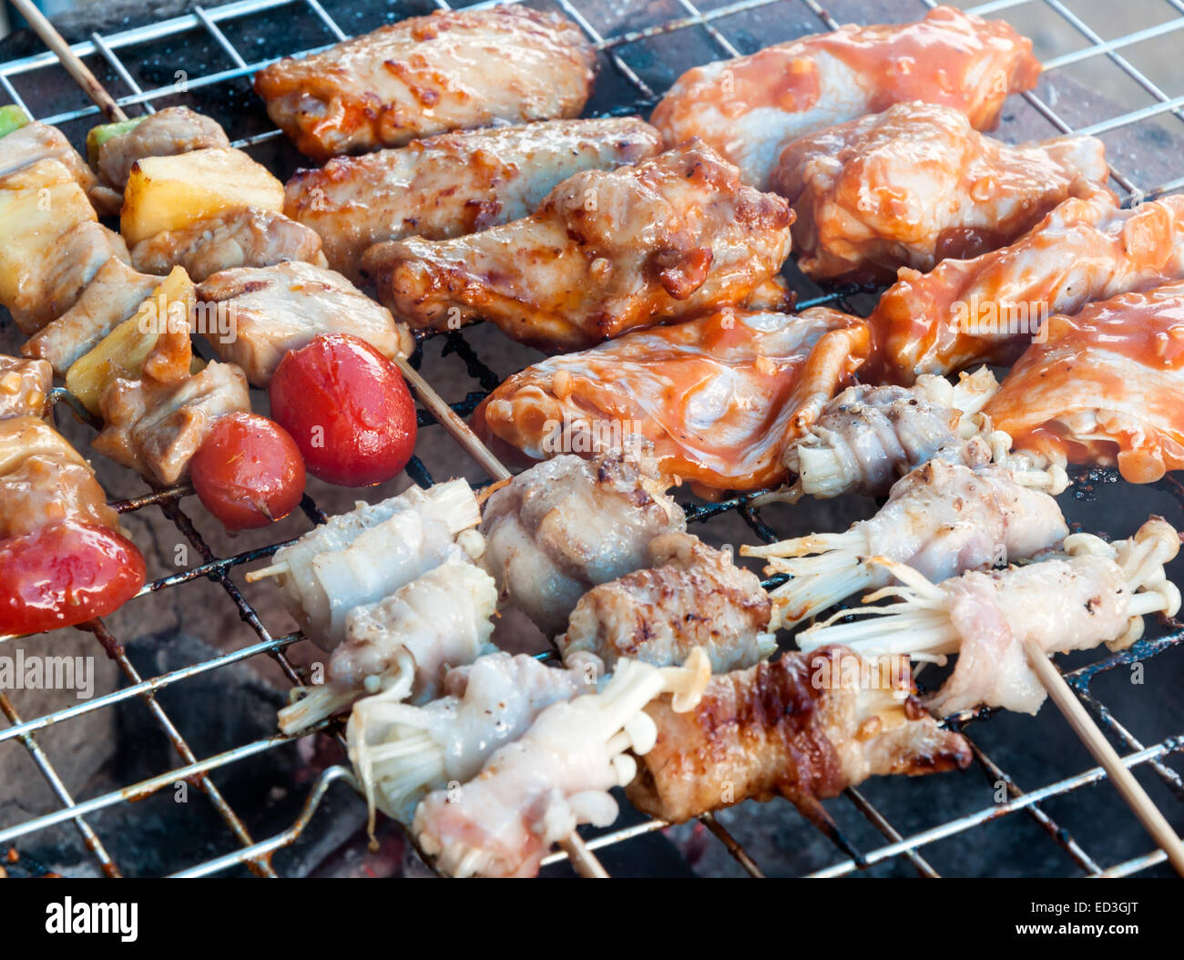 Mix barbecue on the matel grid for small party Stock Photo - Alamy