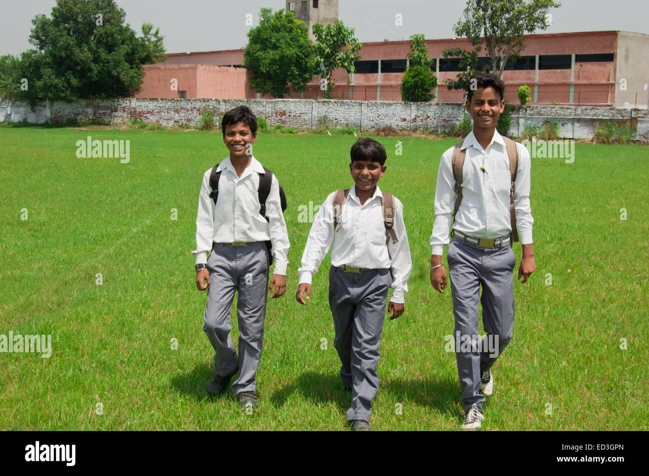 3 indian rural children School Students walking park Stock Photo - Alamy