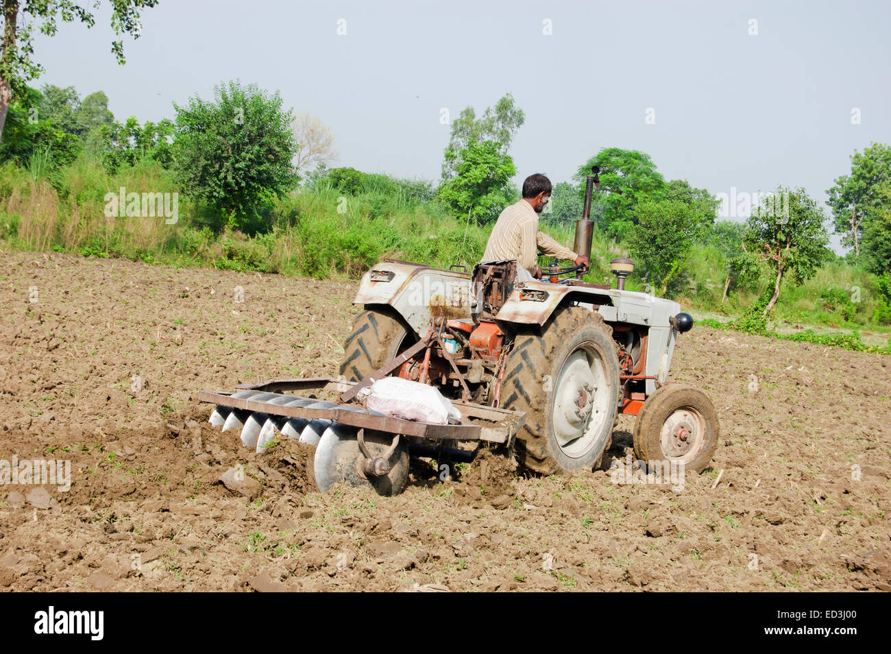 1 rural farmer man farming Tractor Stock Photo - Alamy