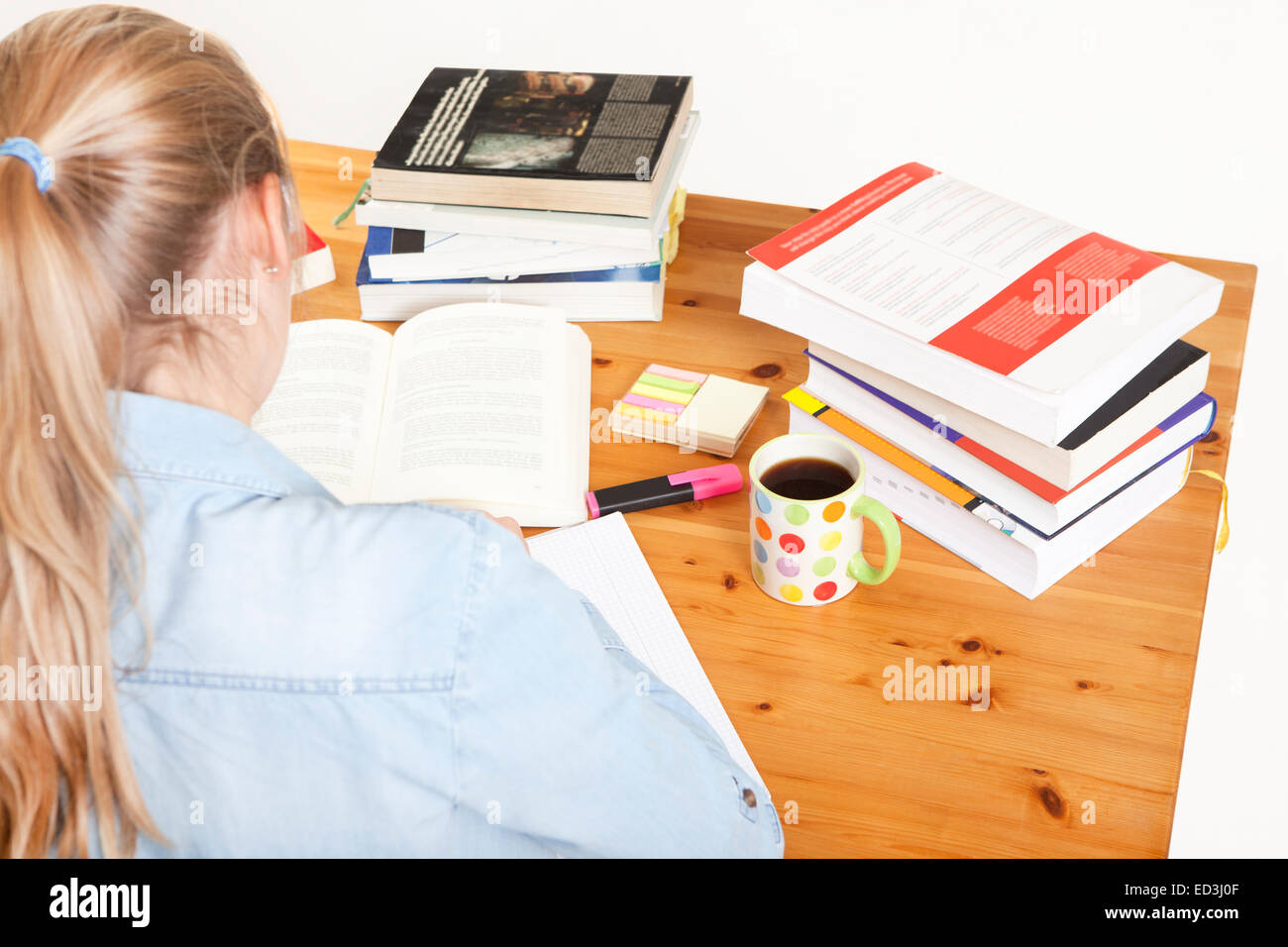 girl sitting at desk and makes homework Stock Photo - Alamy