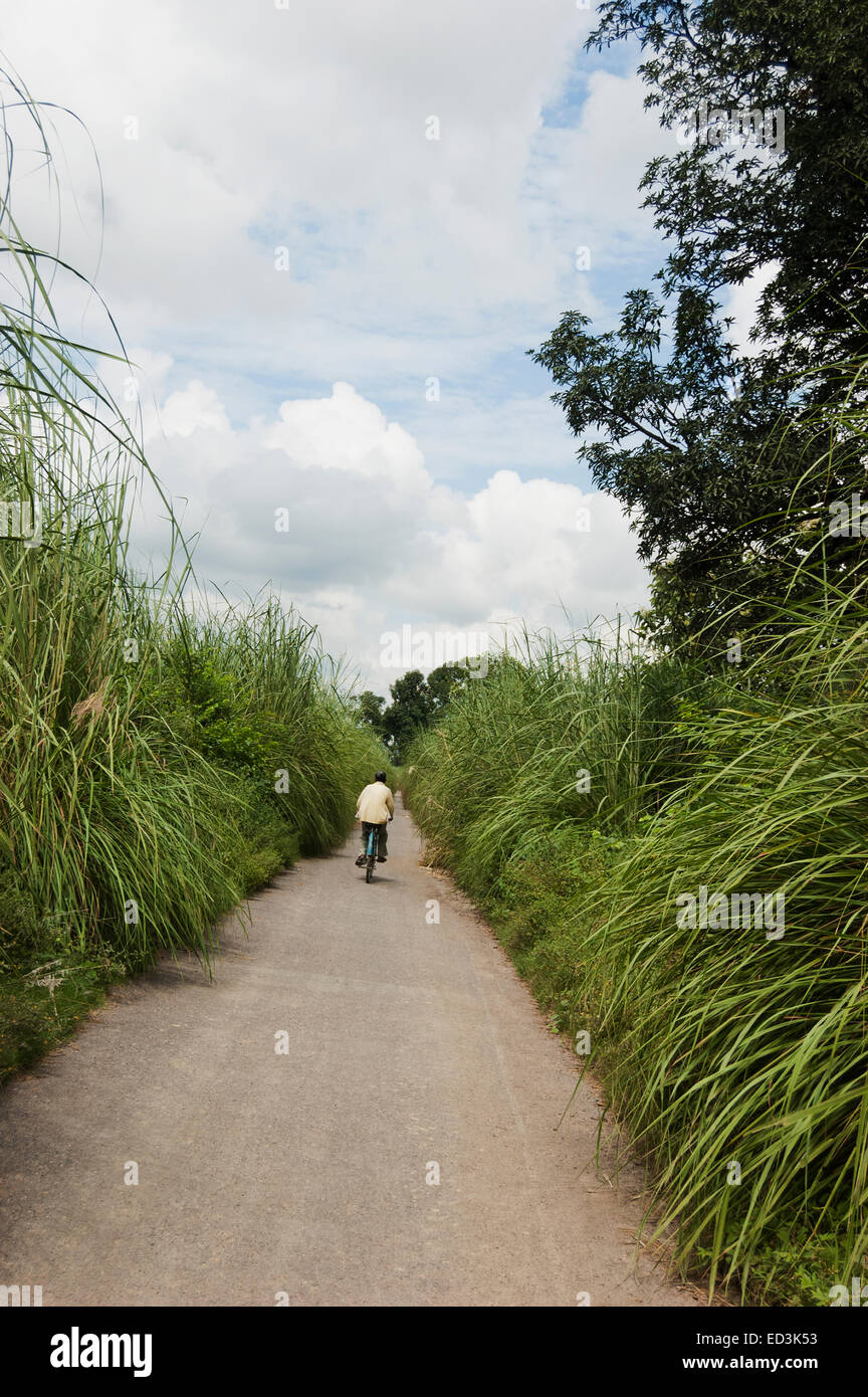 1 Rural man Village Road side Riding Cycle Stock Photo - Alamy